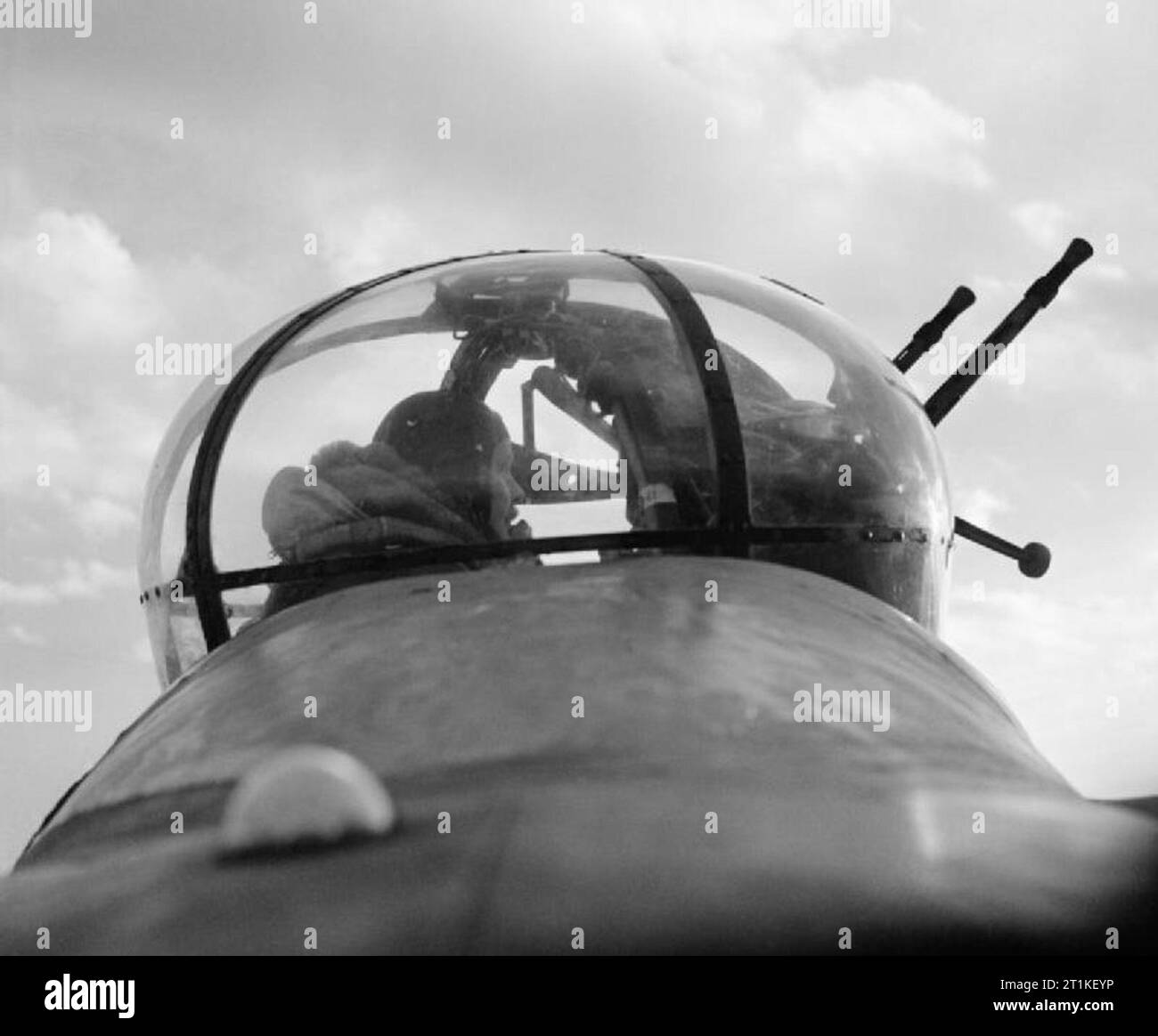 A No. 57 Squadron Lancaster mid-upper gunner in his turret, February ...