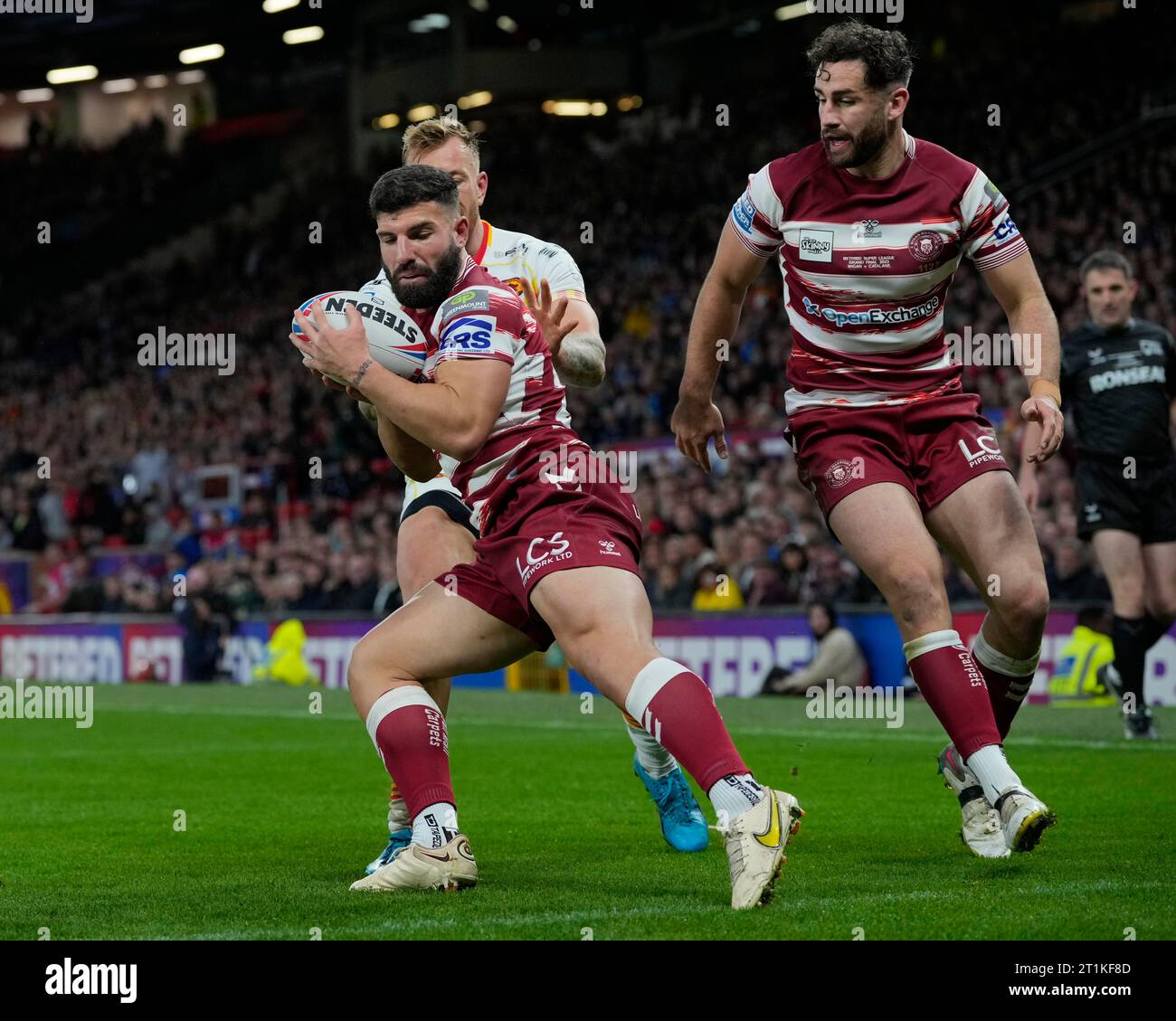 Abbas Miski #23 of Wigan Warriors collects a high ball but has his foot ...