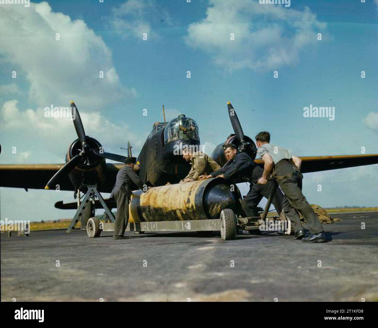 Royal Air Force ground crew push a 4,000lb blast bomb towards the bay ...