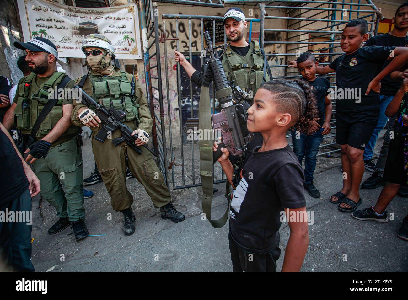Tulkarm, Palestine. 14th Oct, 2023. A child seen carrying a weapon next ...