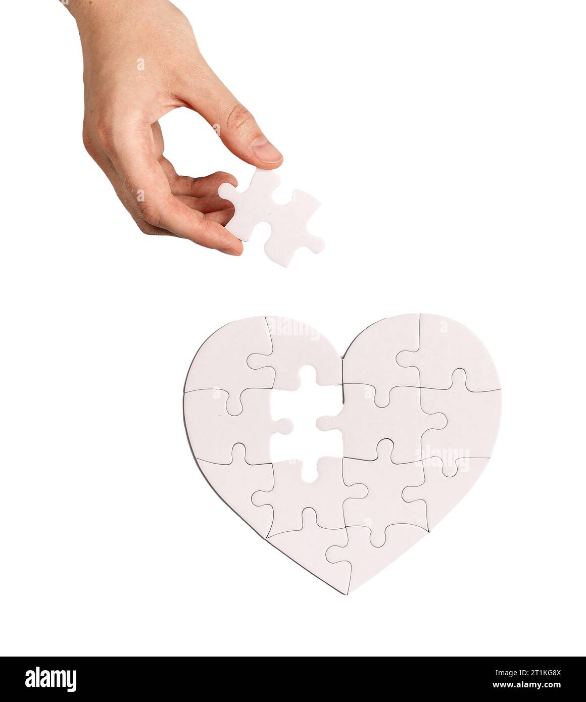 Adding last puzzle piece to complete jigsaw, love heart Stock Photo - Alamy