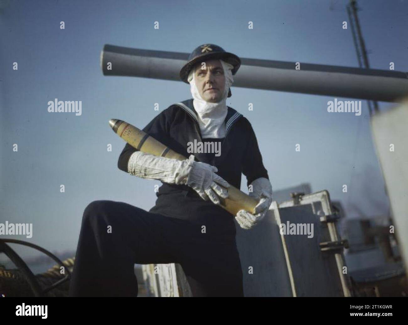 The Royal Navy, November 1943 A naval gunner, wearing anti-flash gear ...