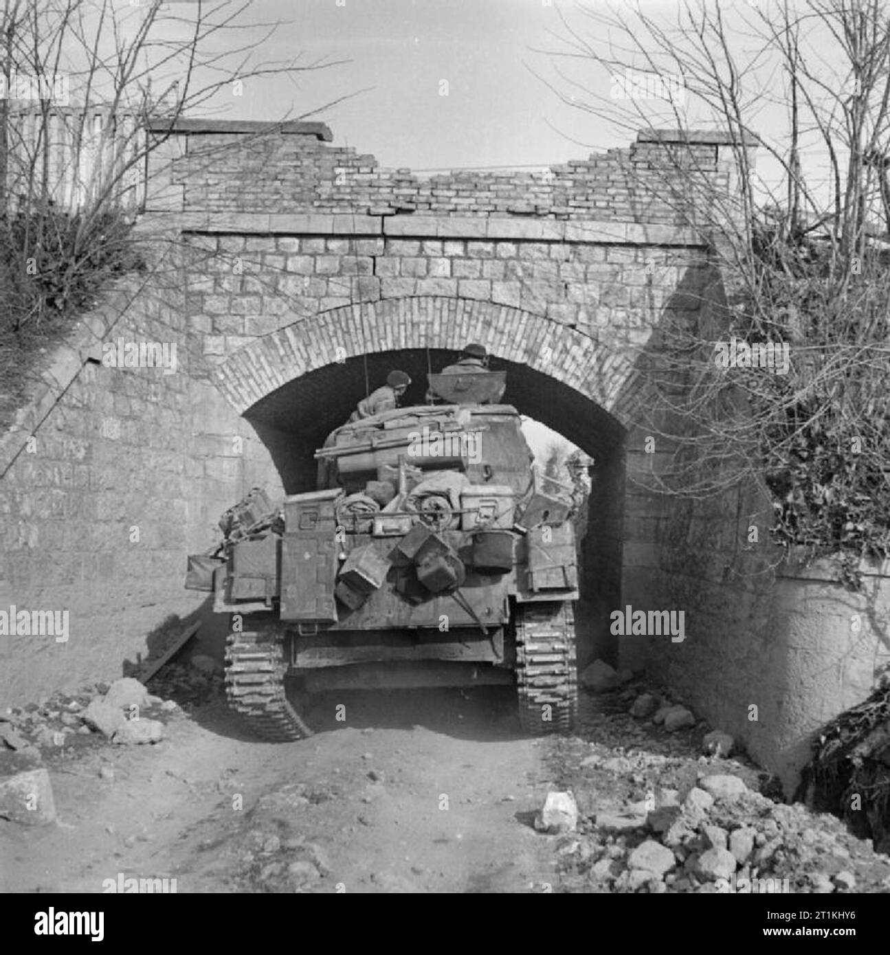 The British Army in Italy 1944 A Sherman tank squeezes under a low ...