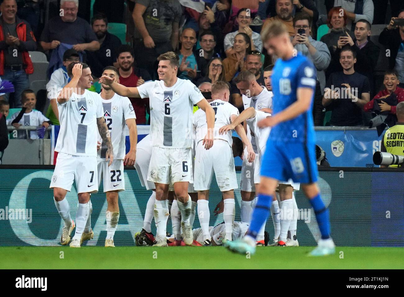 Slovenia's Erik Janza, covered by his teammates, celebrates after ...