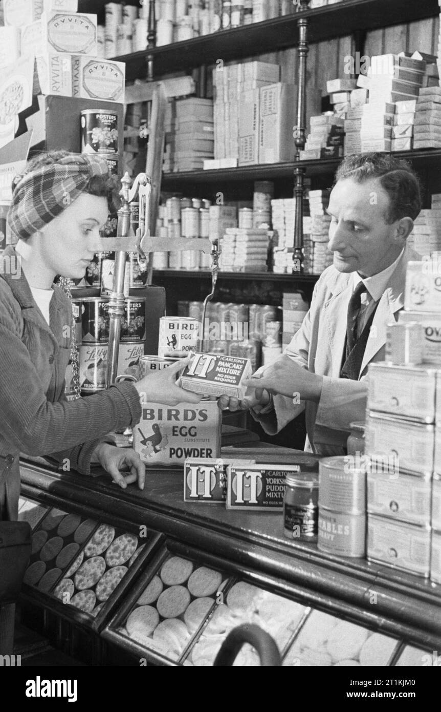 Customer making a purchase in a grocery shop during the Second World ...