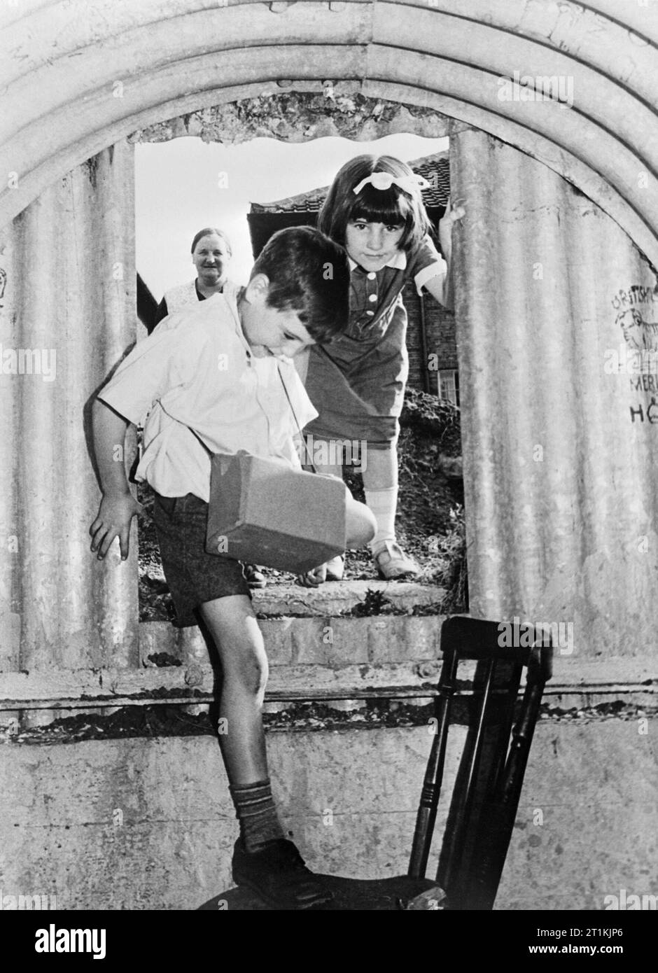 Doris and Alan Suter entering the Anderson shelter in their garden at ...