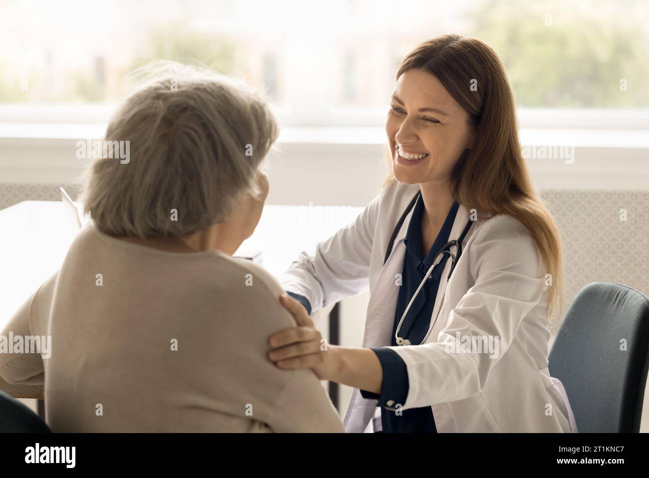 Medical worker support to old lady in clinic Stock Photo - Alamy