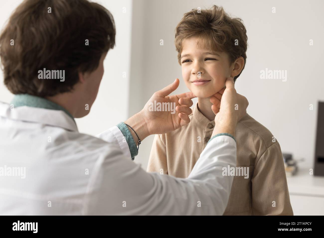 Young male doctor check little patient tonsils during visit Stock Photo ...