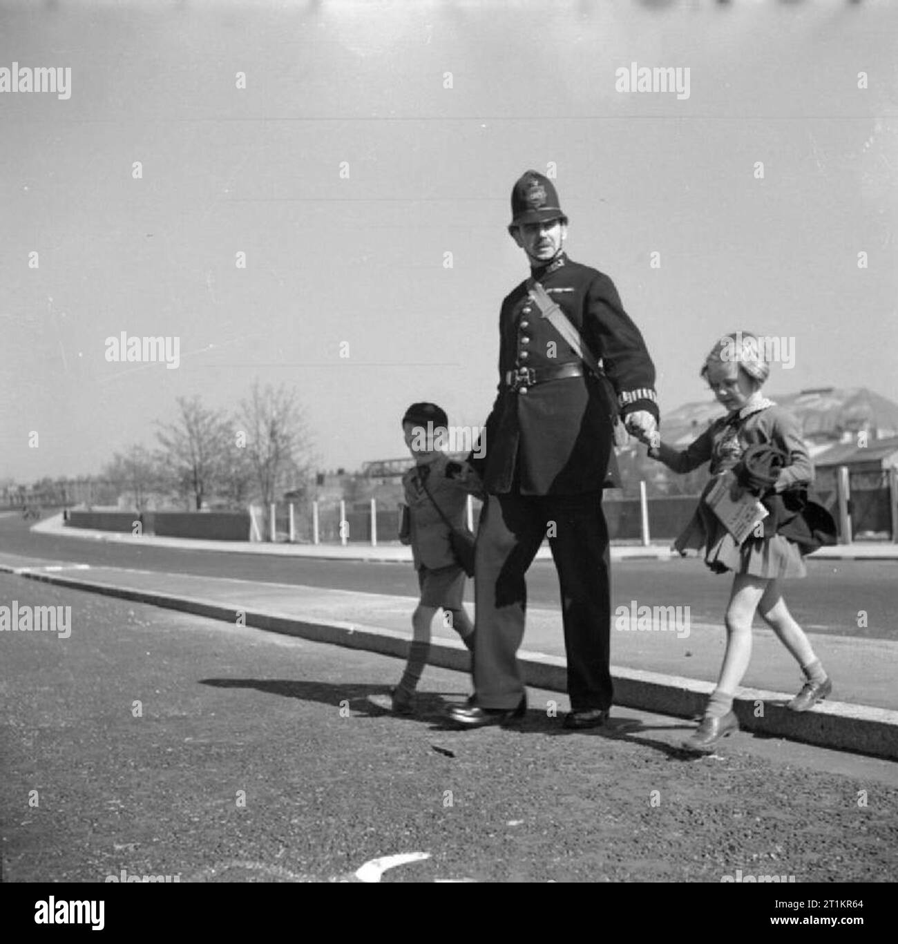 Safety First- Road Safety For Children, England, 1942 A policeman helps ...