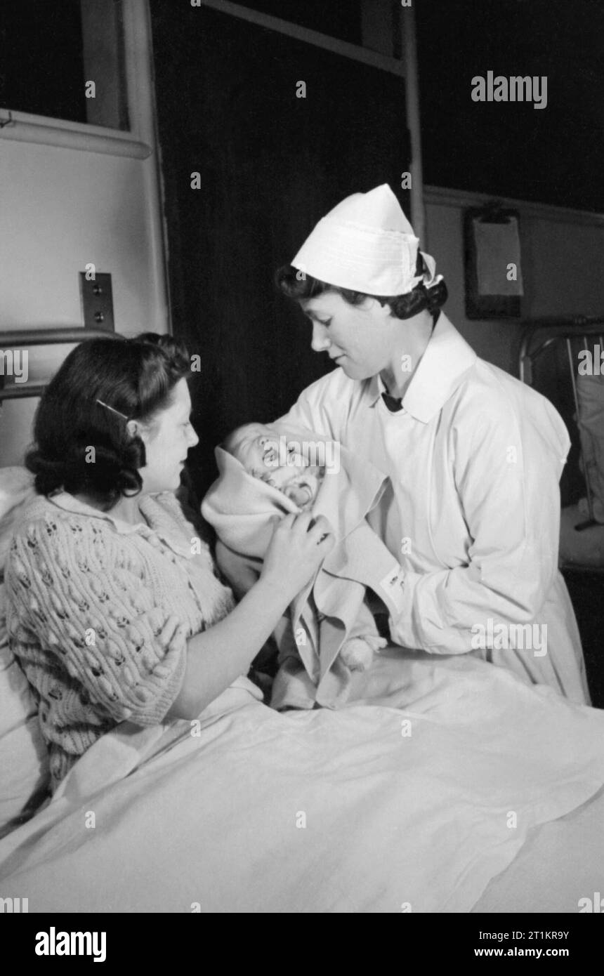 Sister Gwendoline Murphy hands two-day-old Peter Winston Stacey to his ...