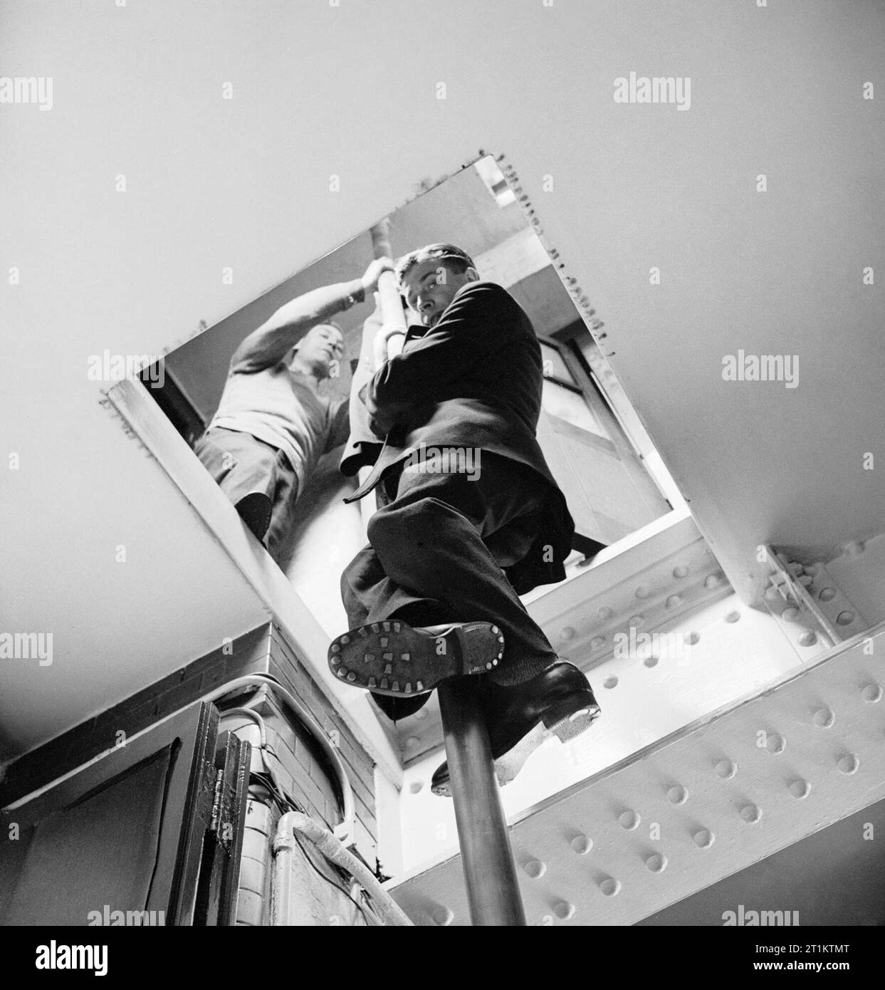 A fireman of the National Fire Service slides down the fireman's pole ...