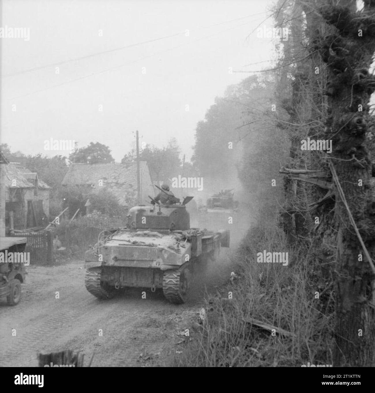 The British Army in Normandy 1944 A Sherman flail tank advances through ...
