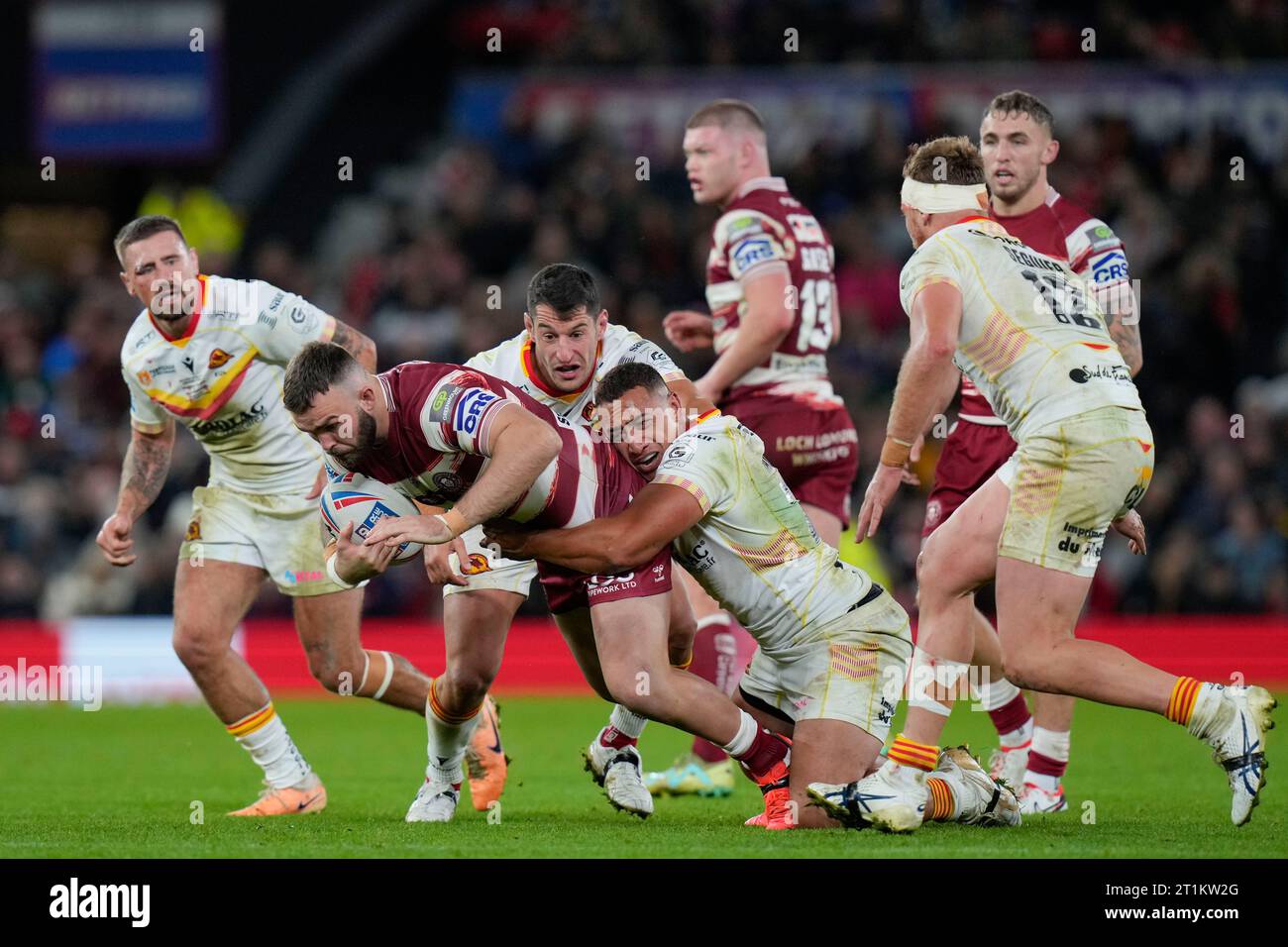 Kaide Ellis #15 of Wigan Warriors is held by the Catalans Dragons ...