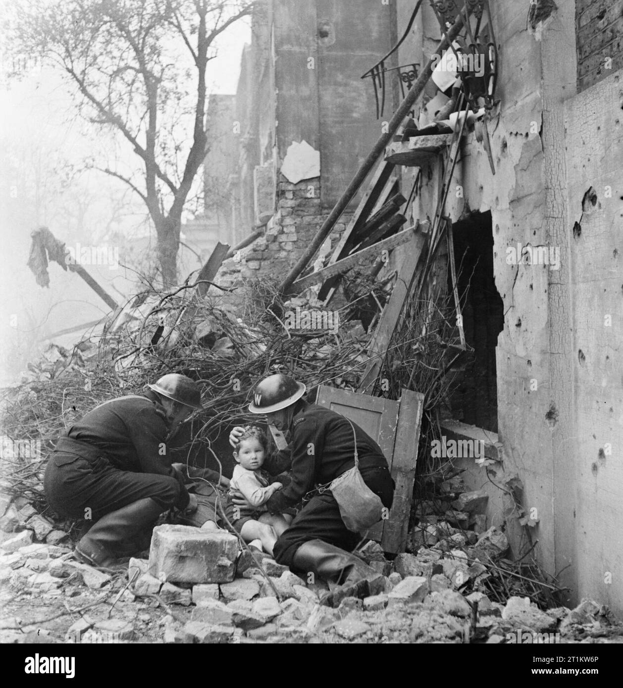 Wardens 'rescue' a young boy from the rubble and debris next to a bomb ...