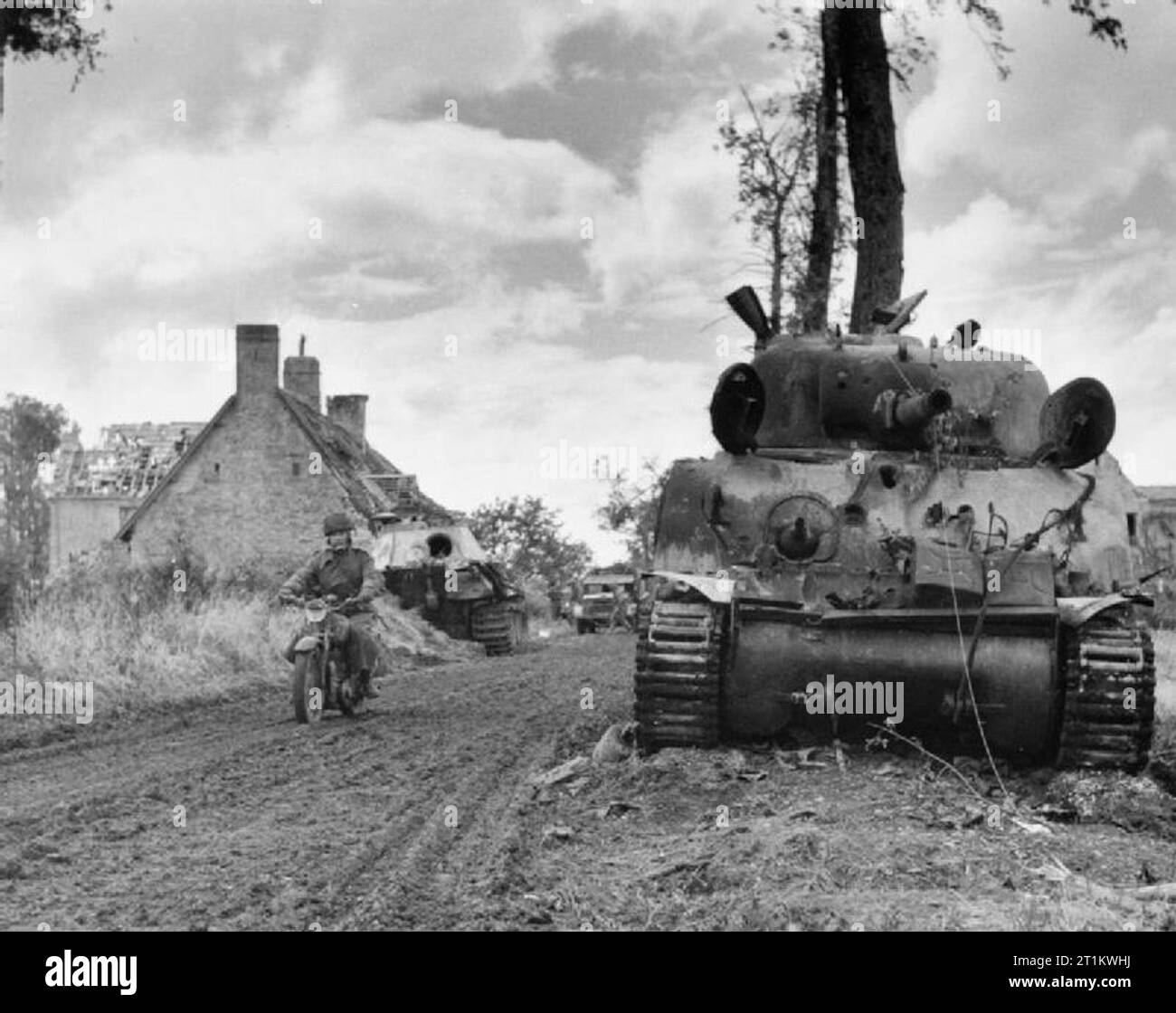 The British Army in Normandy 1944 A motorcycle despatch rider passes a ...