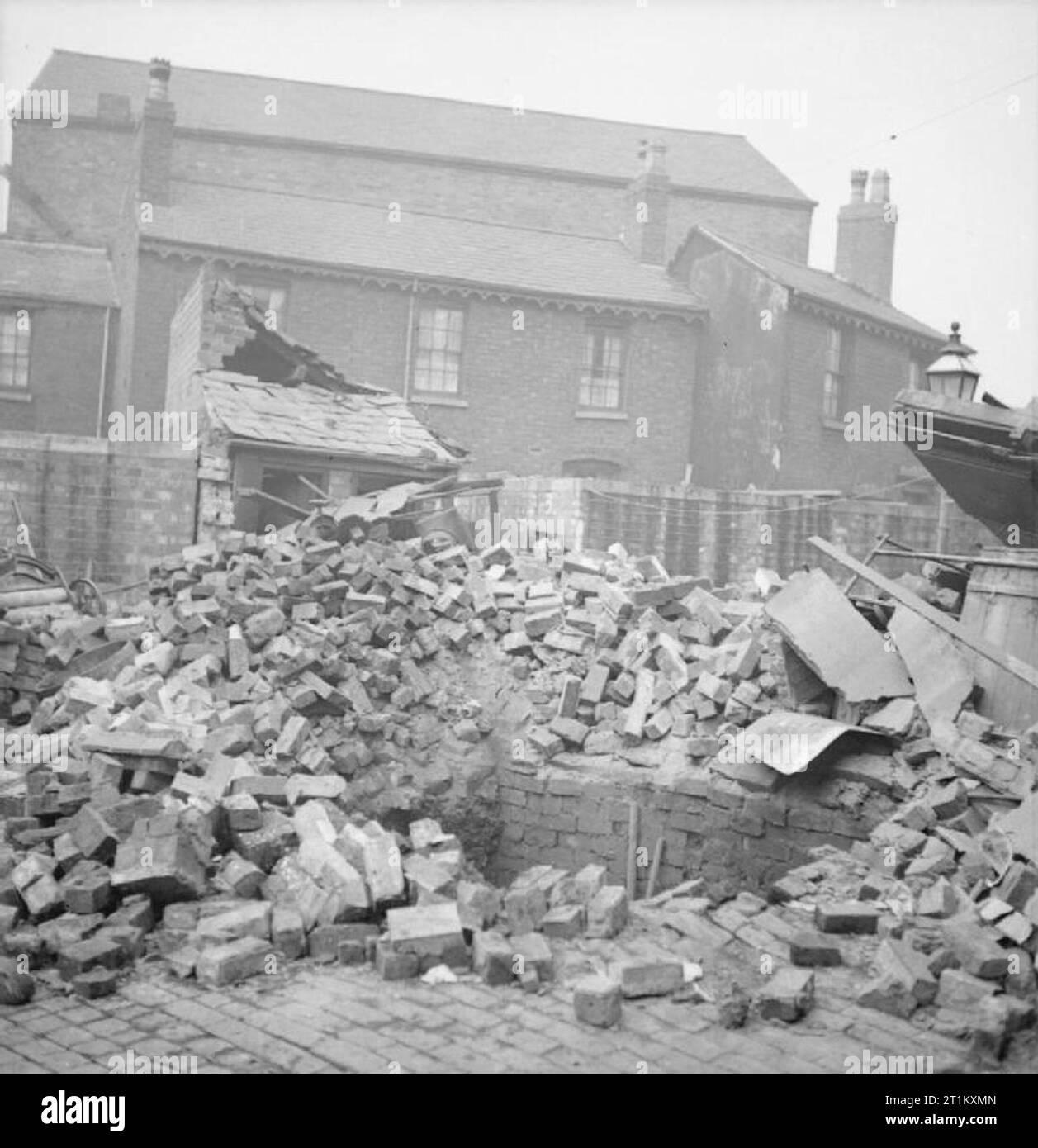 Bomb Damage in Birmingham, England, 1940 A huge pile of brick rubble ...