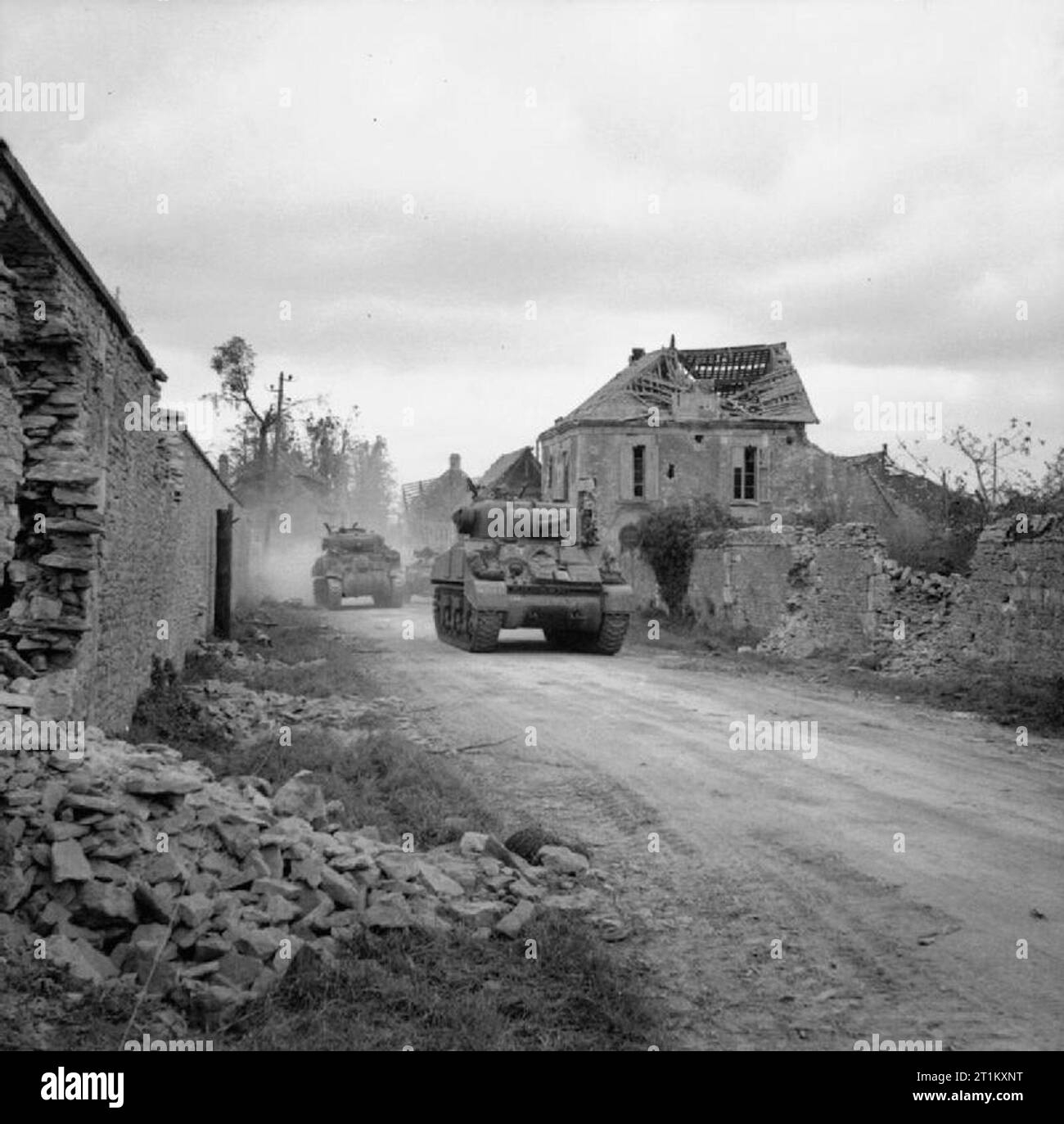 The British Army in Normandy 1944 Sherman tanks move through Lebisey, 9 ...