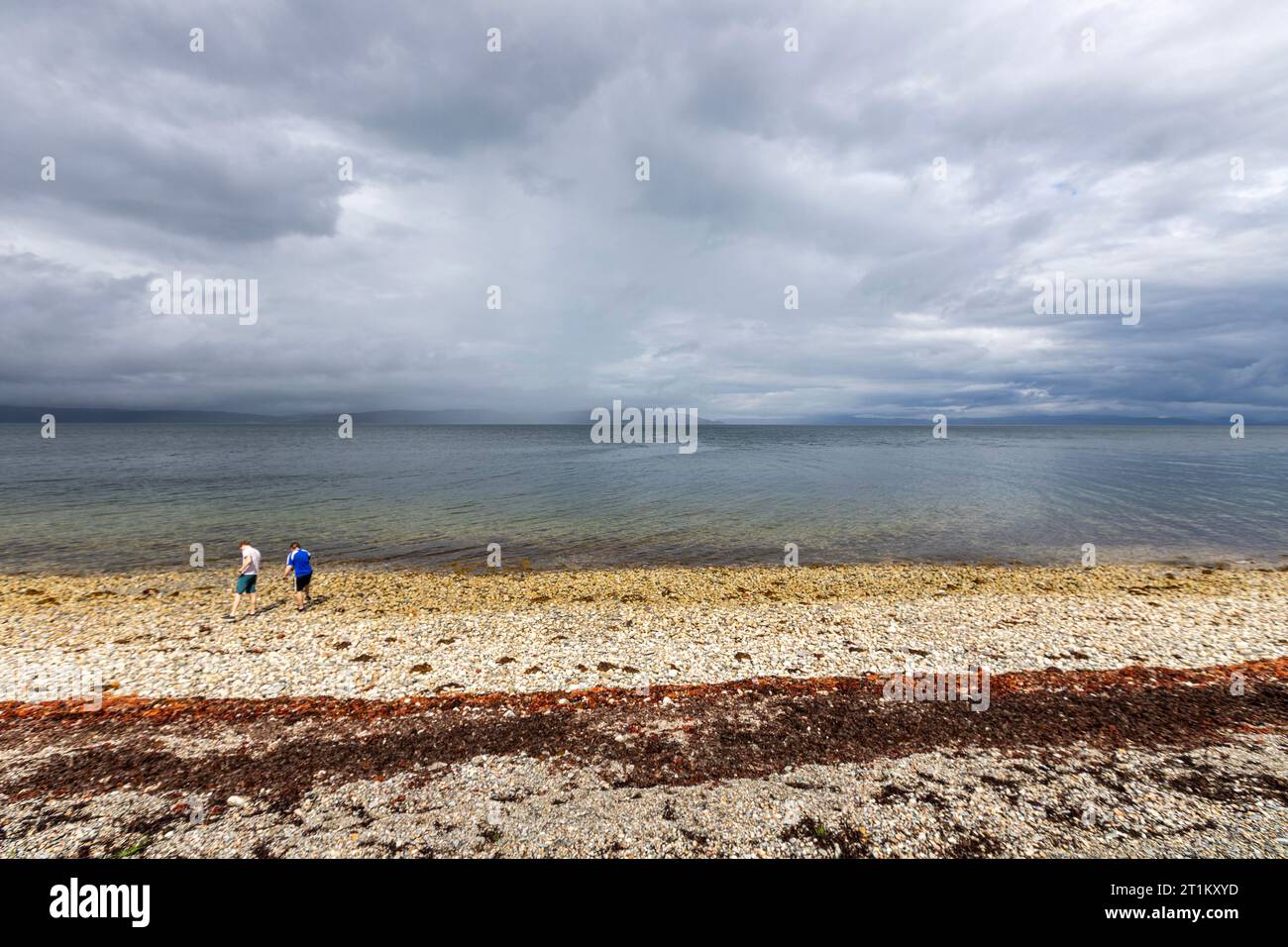 Men in Pebble beach along A841 near Lochranza, Isle Of Arran, Firth of ...