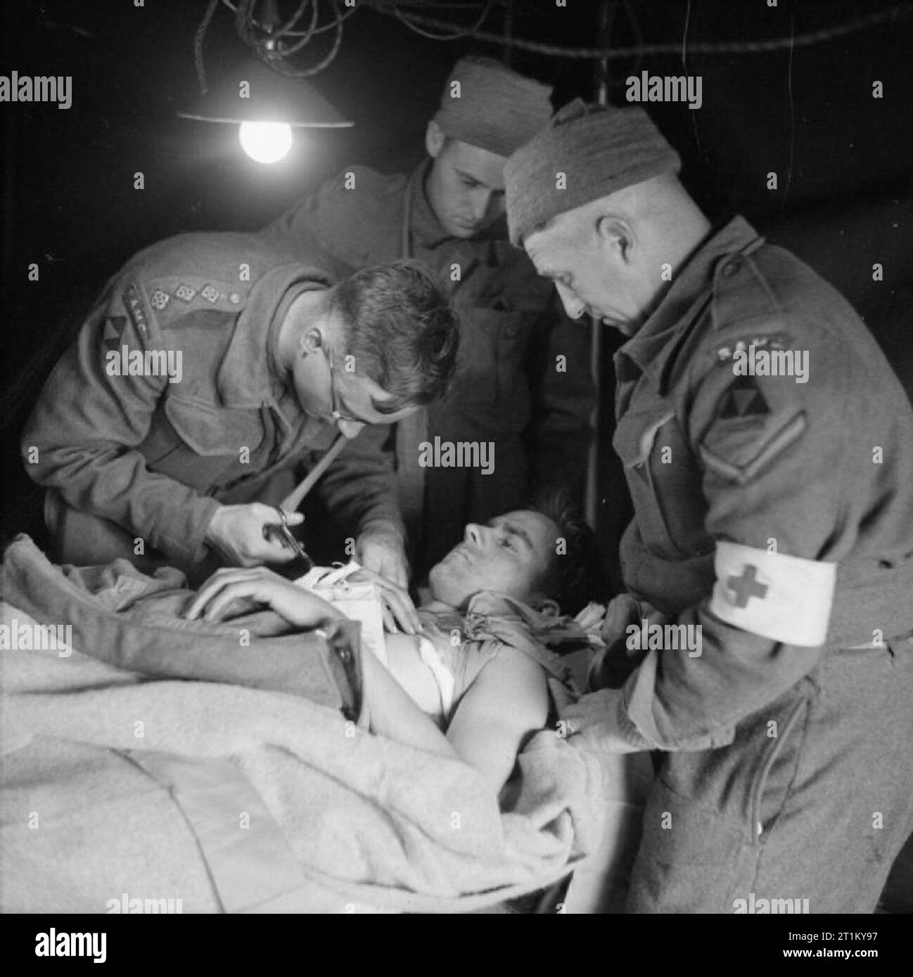 The British Army in Normandy 1944 A wounded soldier having his wounds ...