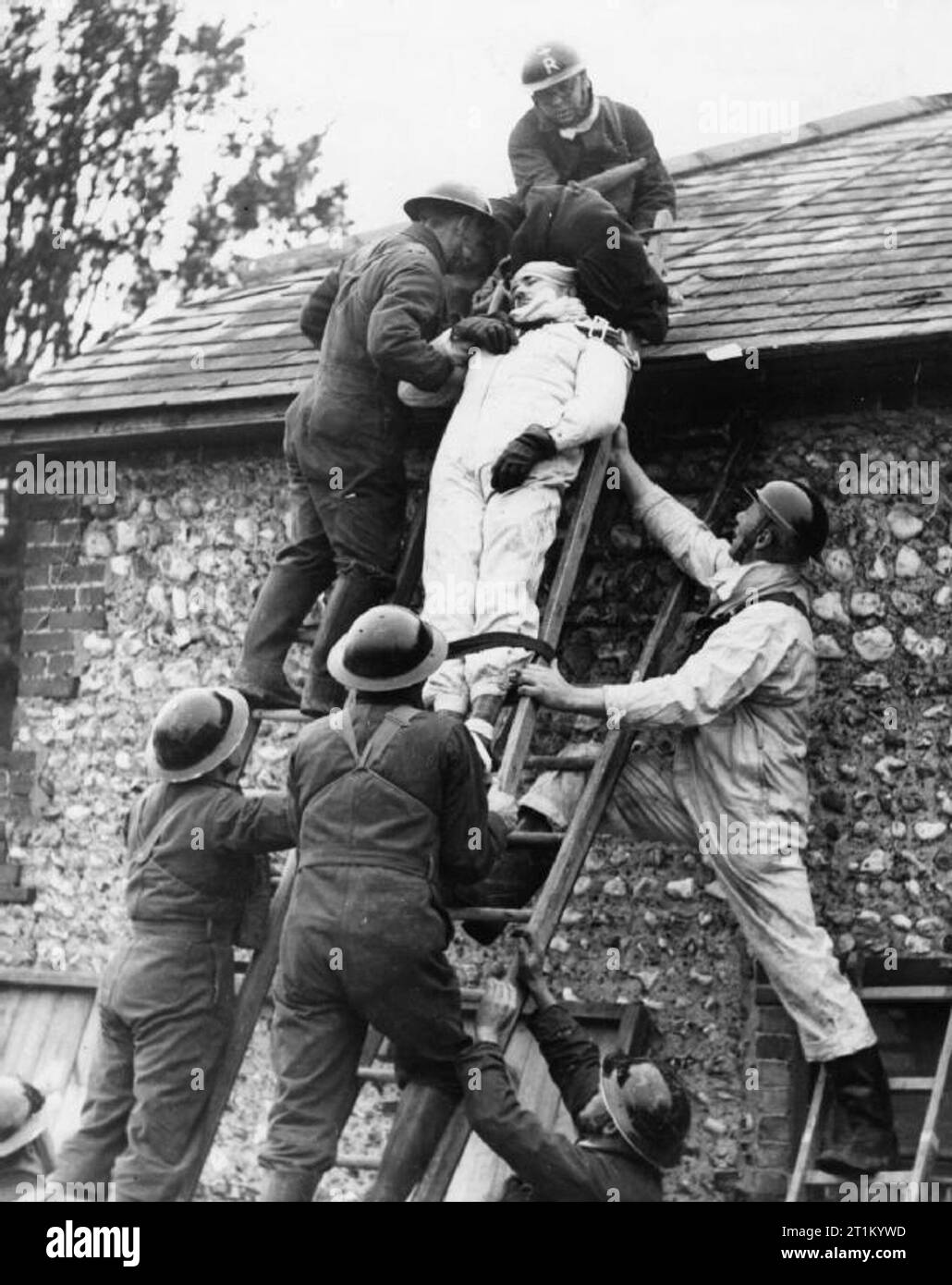 Air Raid Precautions, 1940 A 'casualty', tied to a wooden ladder, is ...