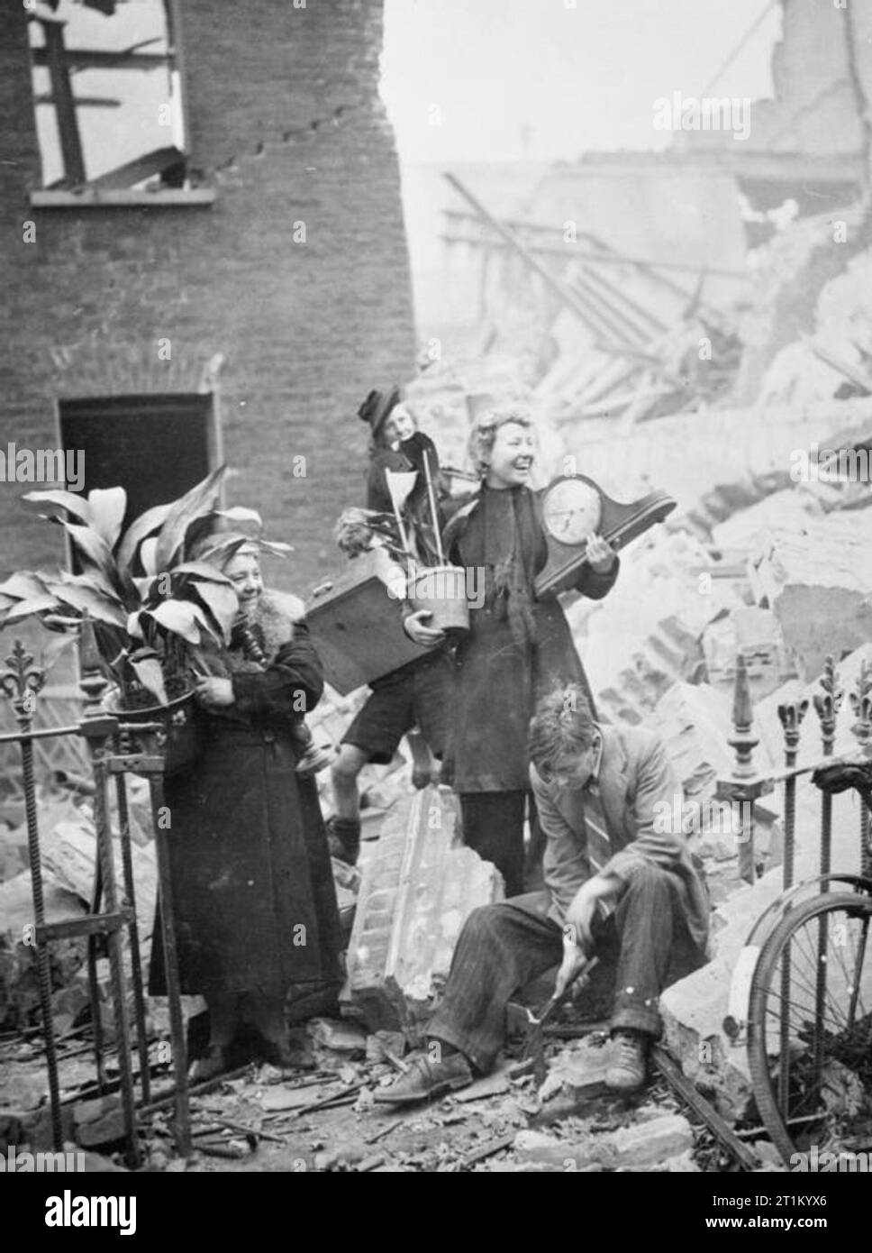 Air Raid Damage in London, 1940 Women salvaging prized possessions from ...