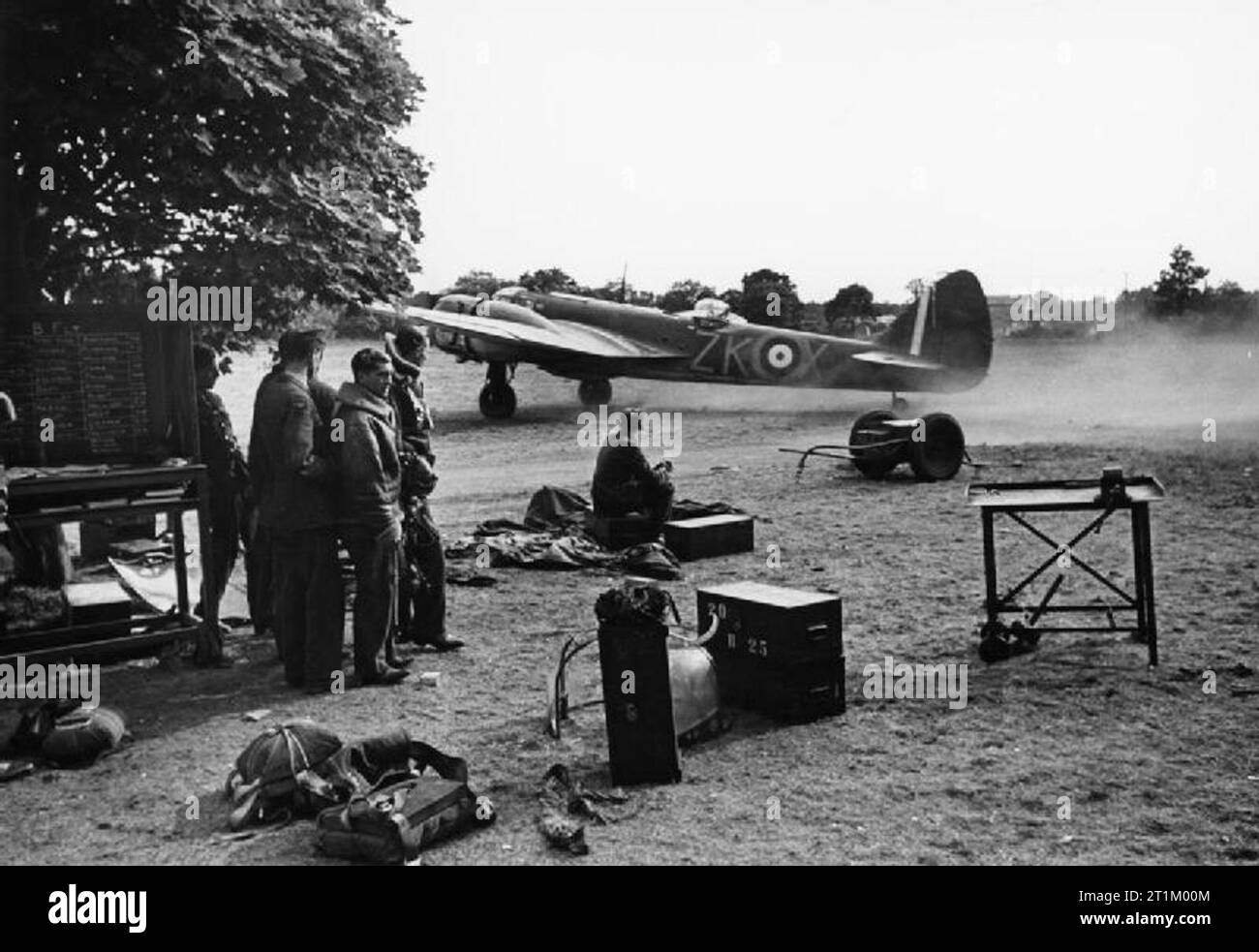 RAF Fighter Command 1940 Blenheim Mk IF of No. 25 Squadron taxying at Martlesham Heath, watched ...
