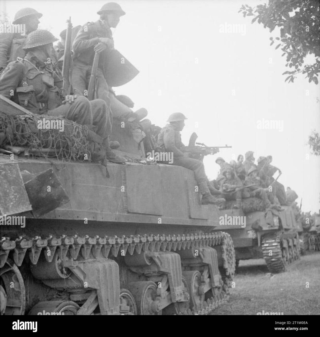 The British Army in Normandy 1944 Sherman tanks carry infantry forward ...