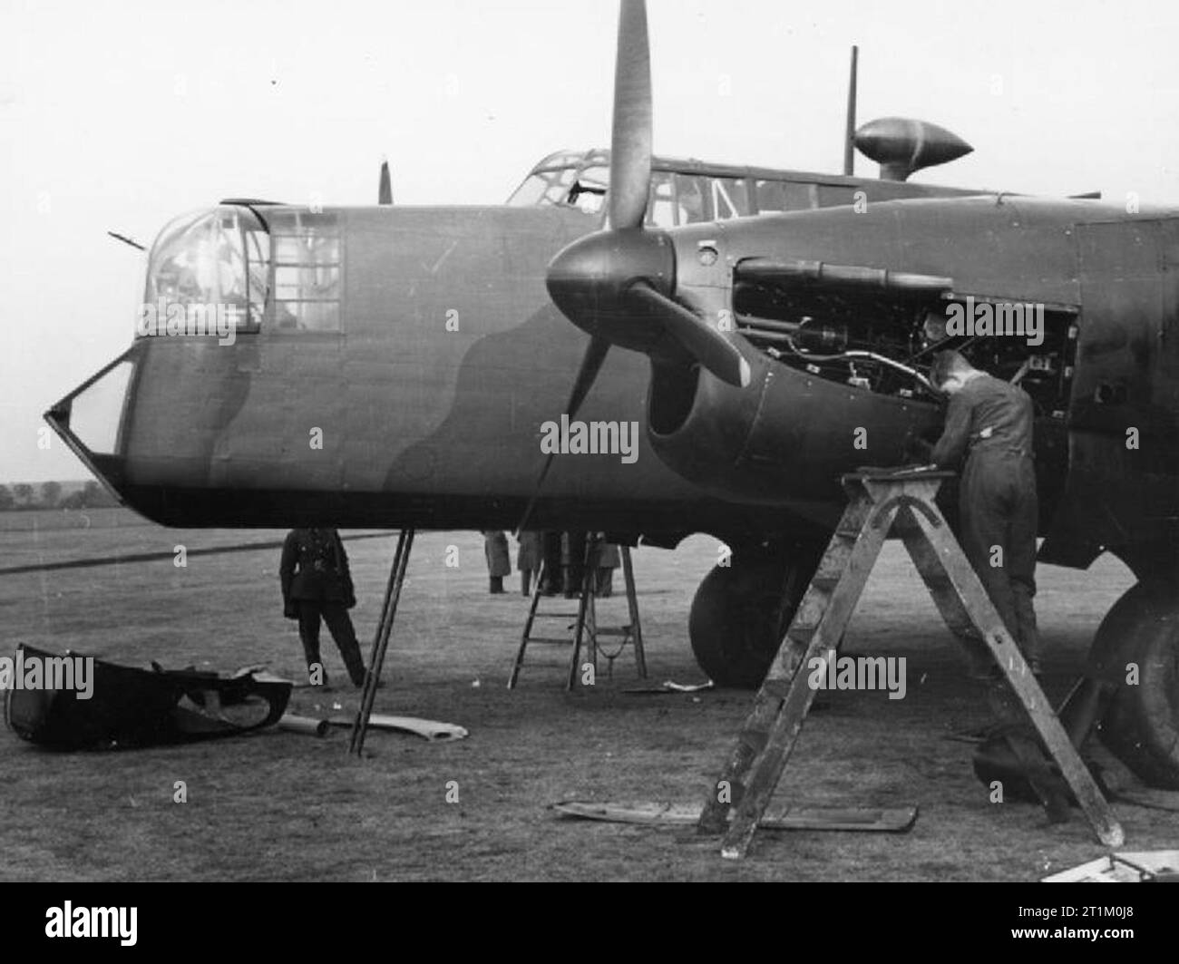 RAF Bomber Command 1940 A fitter works on the engine of a Whitley ...