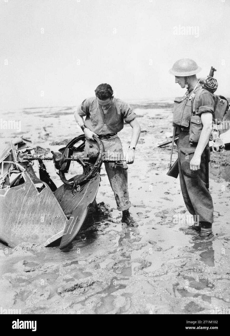 The Battle of Britain Soldiers examine an MG 17 machine gun and part of ...