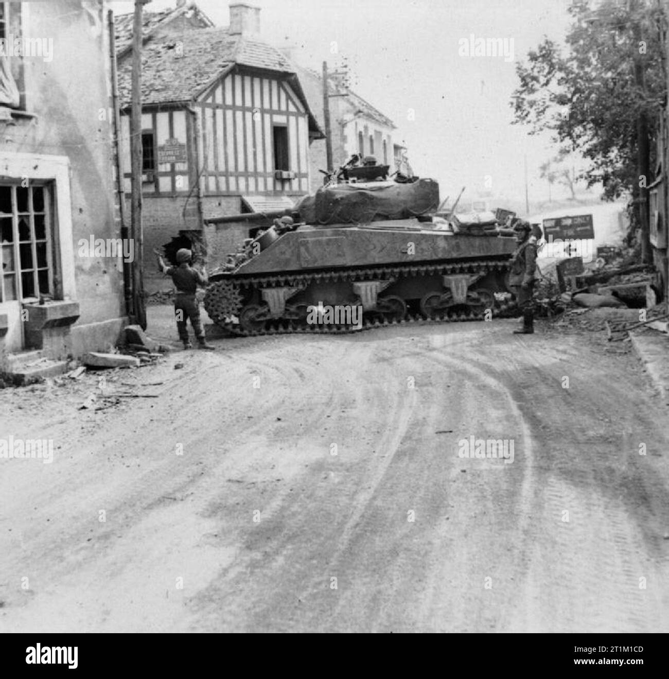 The British Army in Normandy 1944 A Sherman tank negotiates a sharp ...