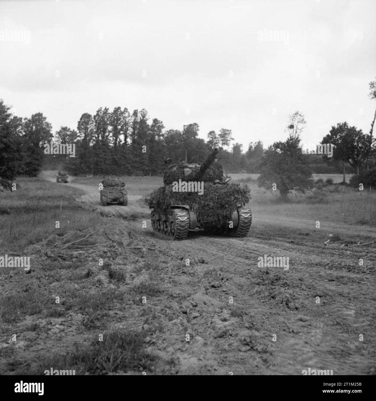 The British Army in Normandy 1944 Camouflaged Sherman tanks moving up ...