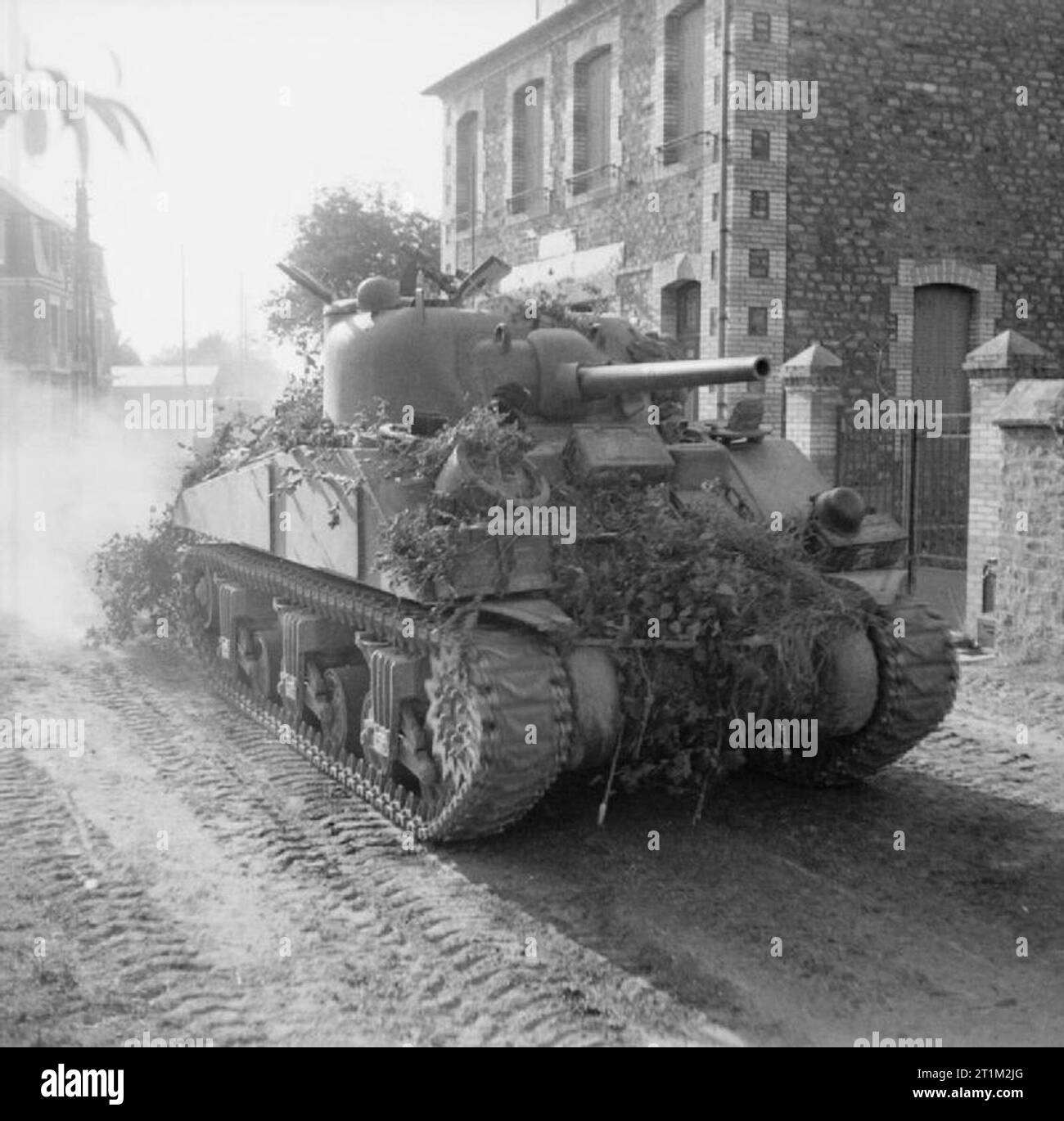 The British Army in Normandy 1944 A Sherman tank passing through Le ...