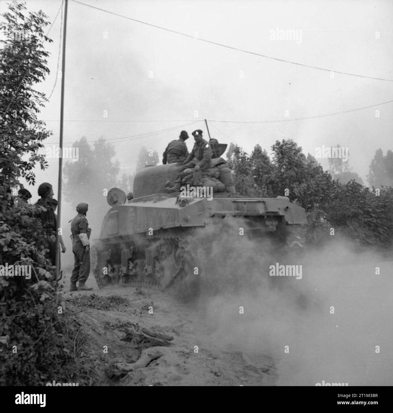 The British Army in Normandy 1944 A Sherman tank drives through a gap ...