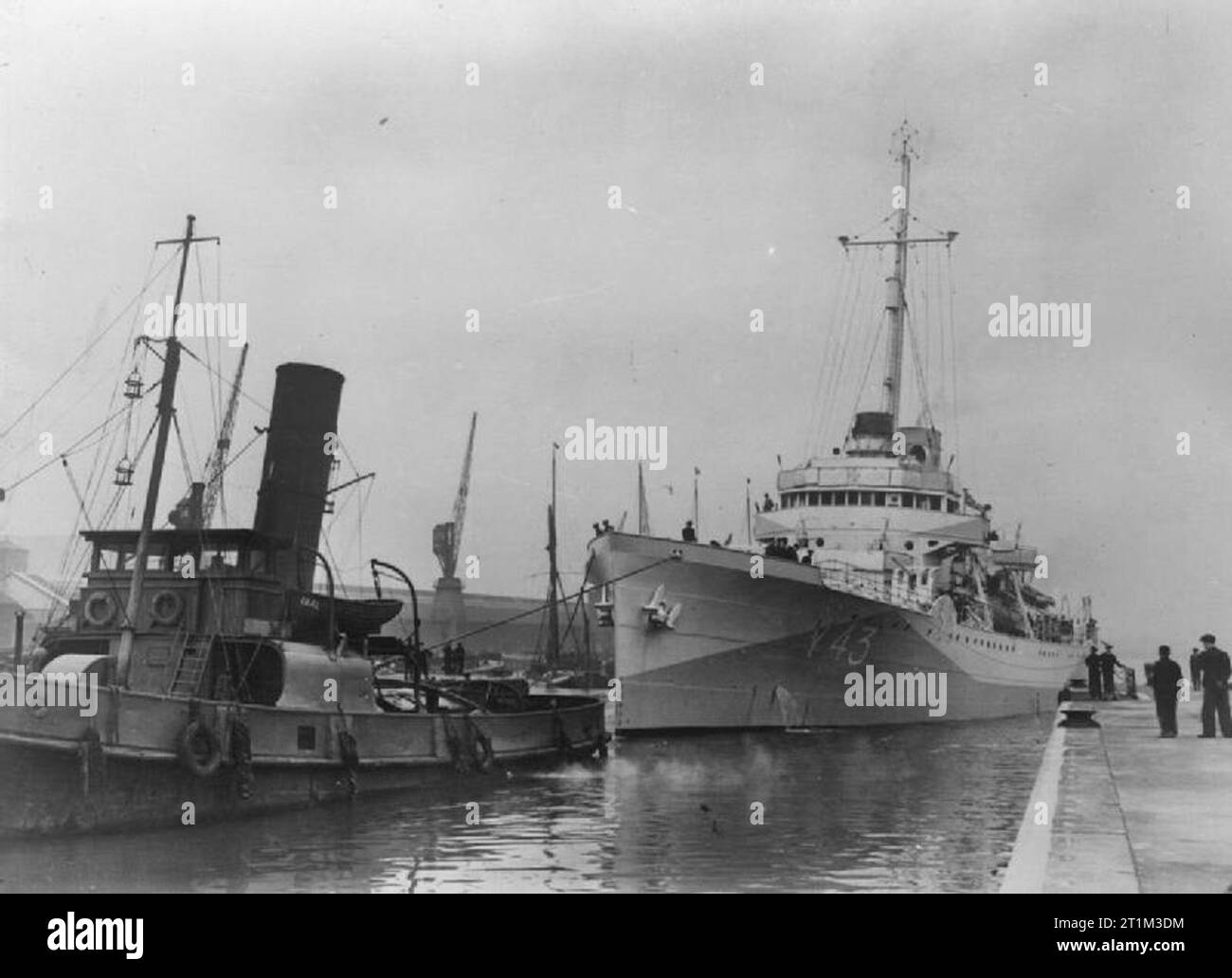 British sloop HMS Banff, coming alongside at Tilbury with tug BADIA ...