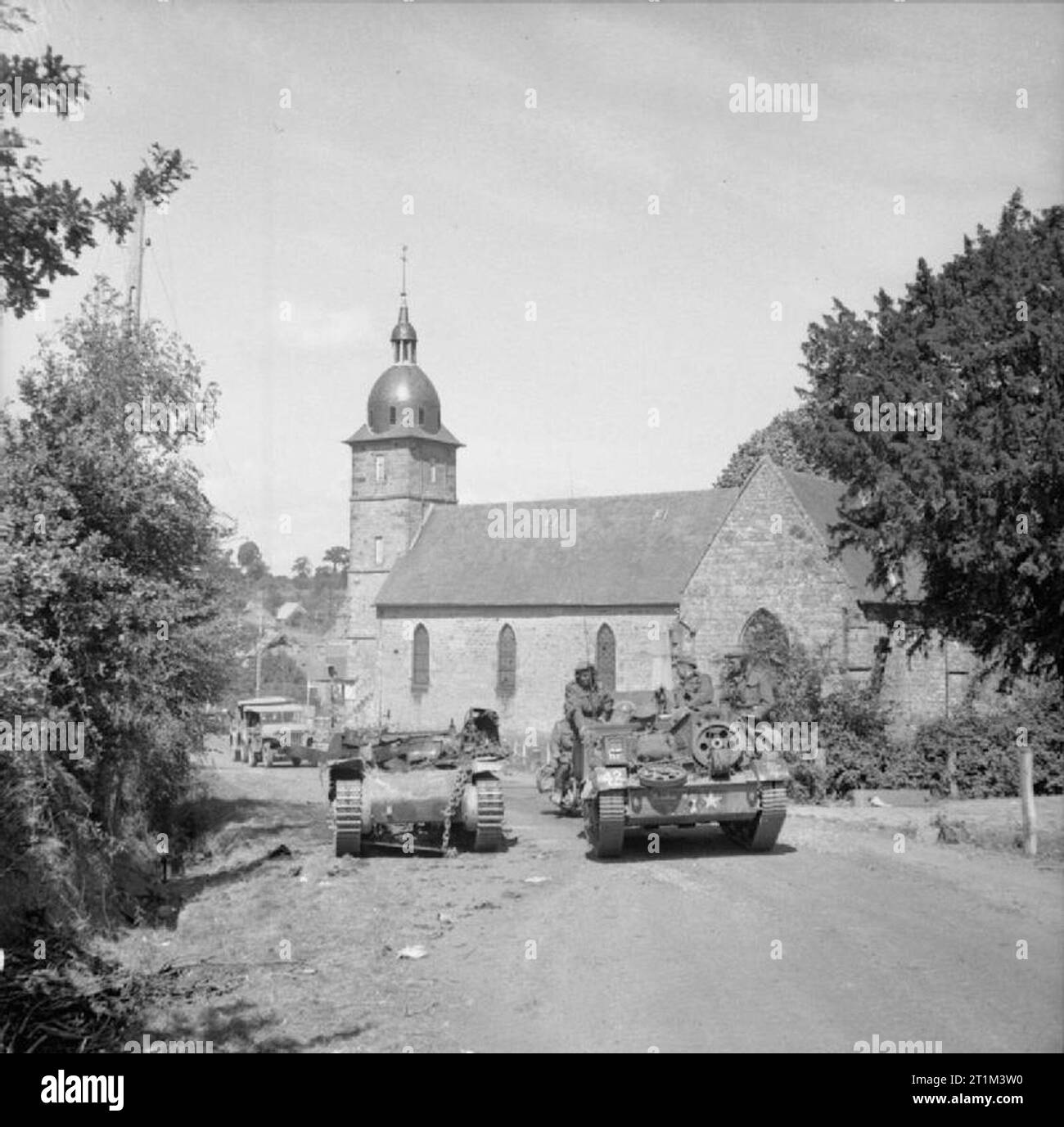 The British Army in Normandy 1944 A Universal carrier passes through the village of St Honorine ...