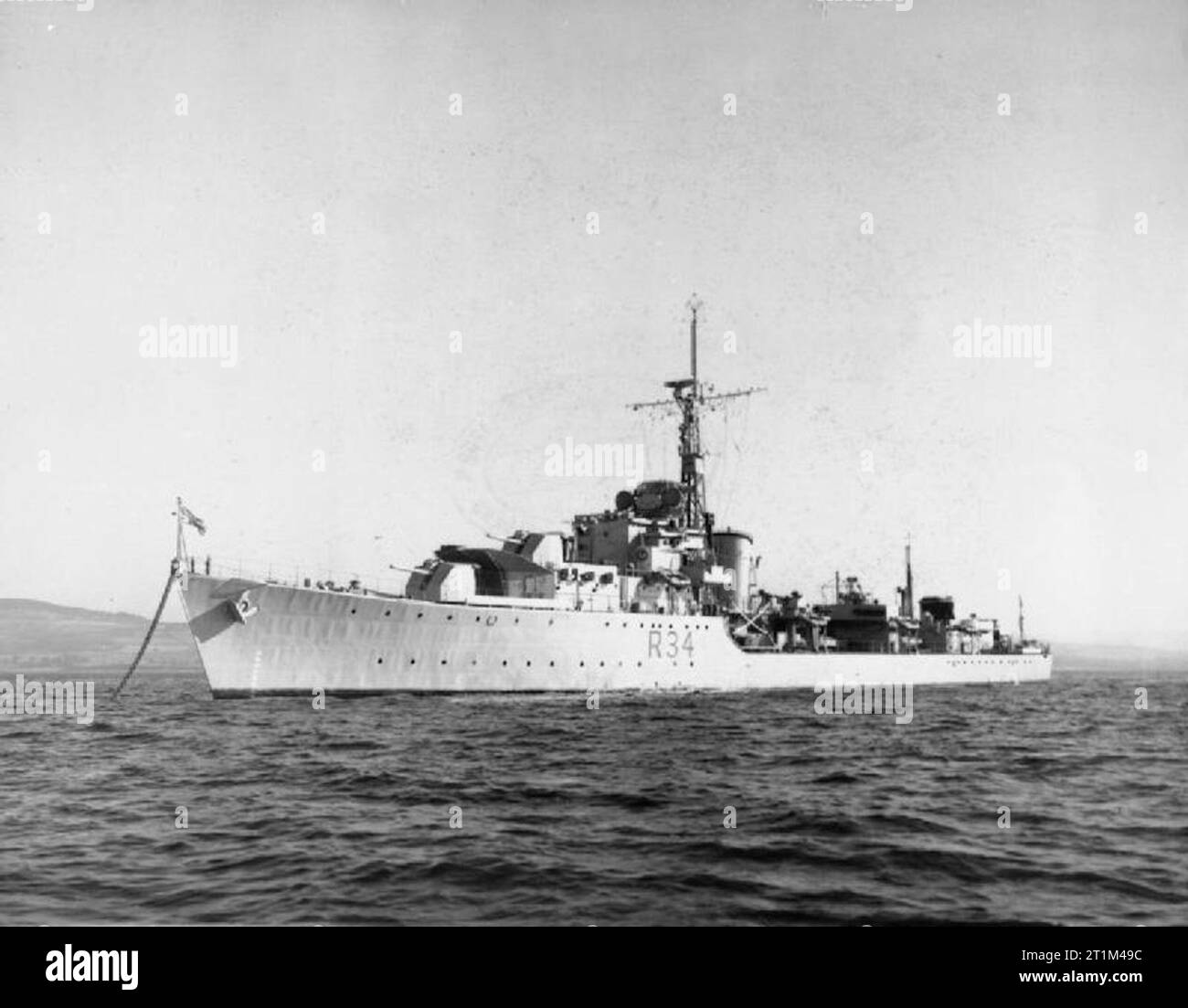 The Royal Navy destroyer HMS Cockade (R34) secured to a buoy in the ...