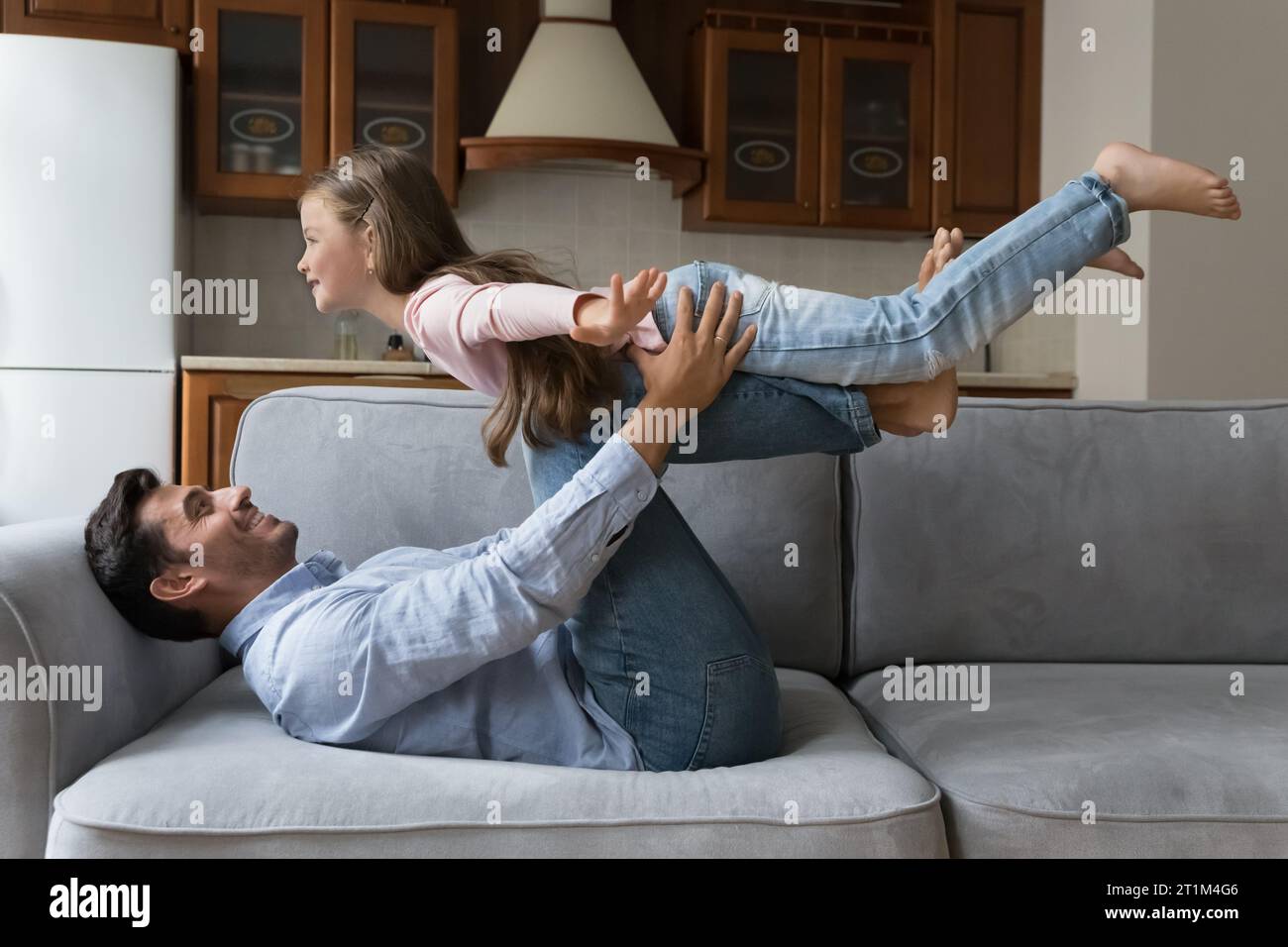 Sportive strong dad keeping balance with happy little kid girl Stock ...