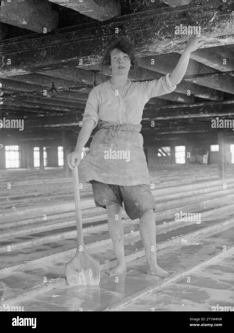 Industry during the First World War A female worker stands barefoot in ...