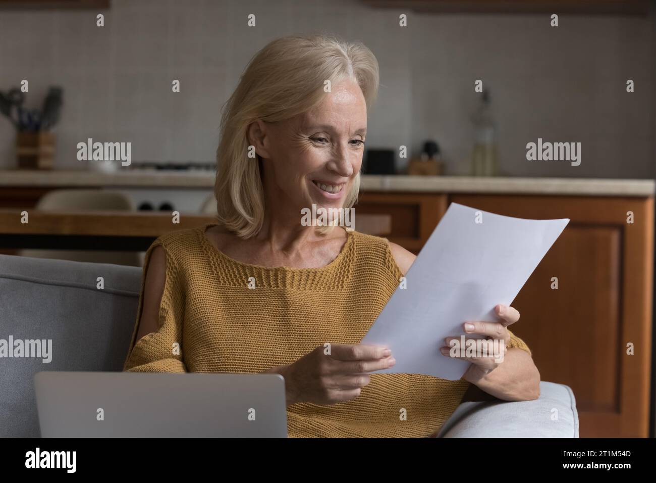 Happy cheerful senior homeowner woman reading paper document Stock ...