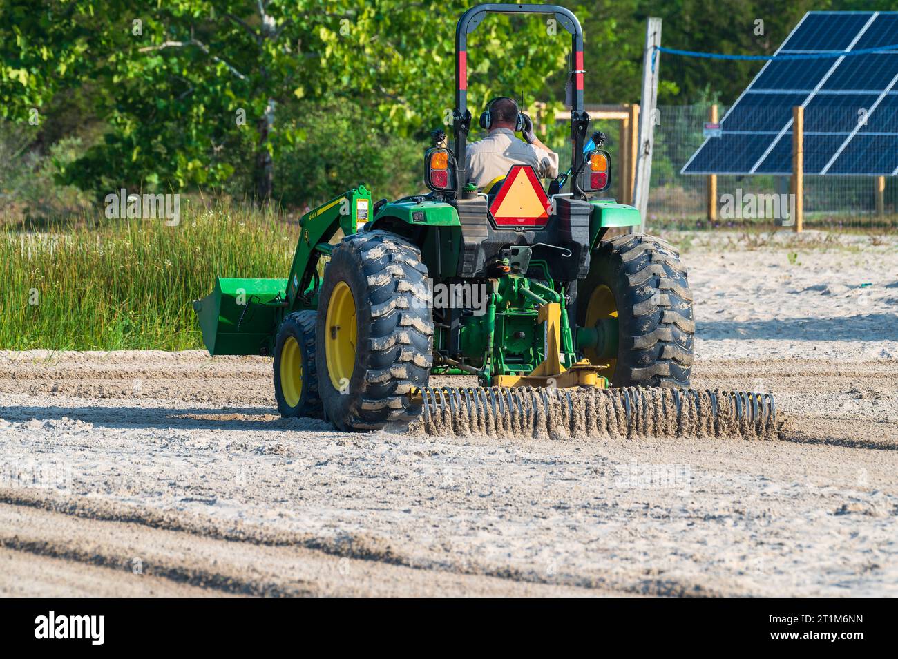 Yankee Springs, MI - July 22, 2023: Tractor cleans the sand by raking ...