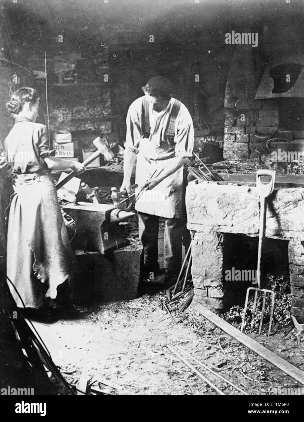 Ministry of Information First World War Official Collection Woman helping her blacksmith husband ...