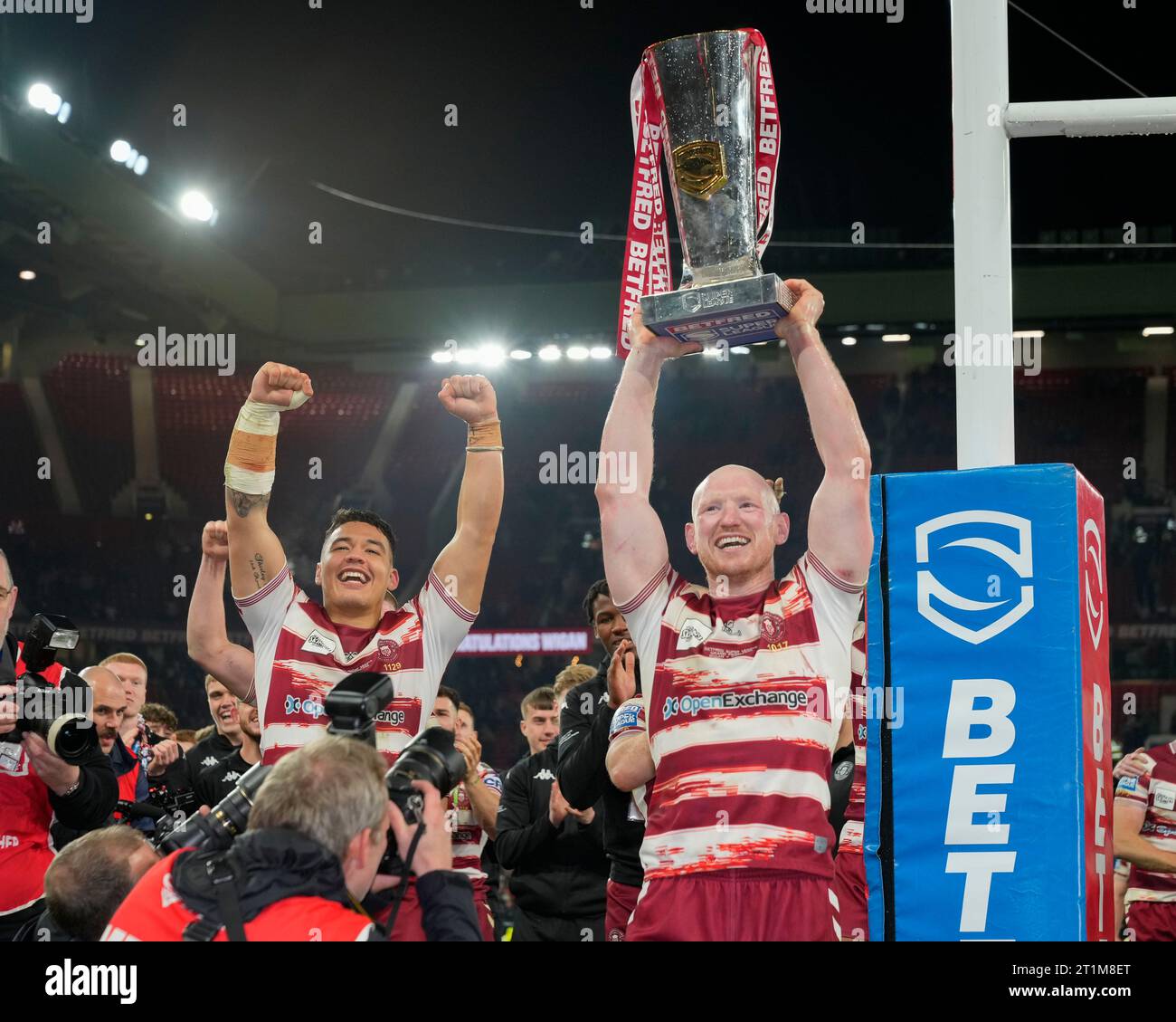 Liam Farrell #12 of Wigan Warriors holds the Super League Trophy aloft ...