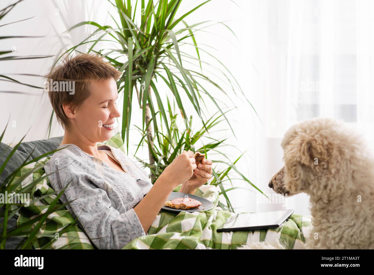 A middle-aged woman, her hair cut short, remains bedridden all day ...