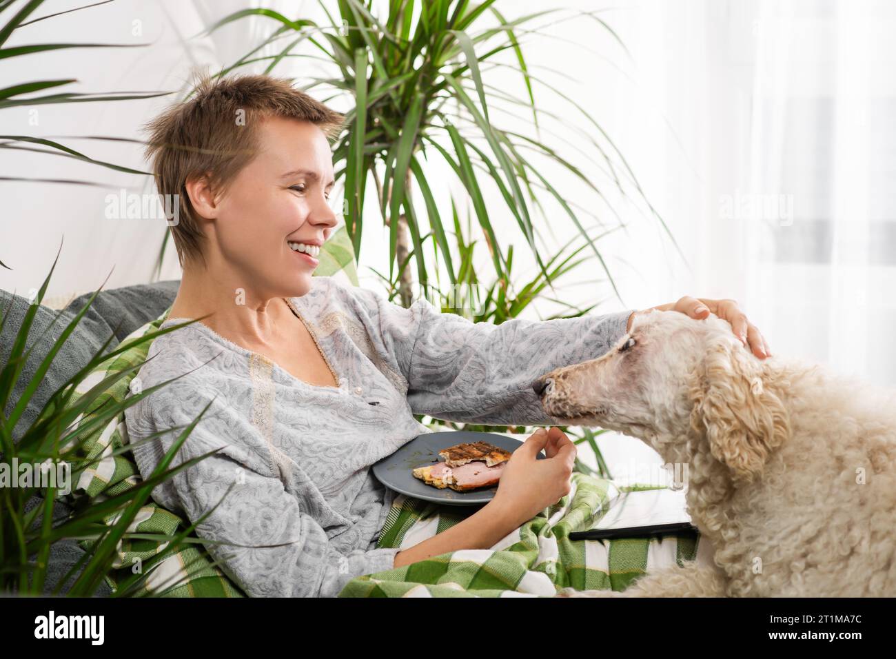 Throughout the day, a woman of middle age, her hair cut short, lies in ...