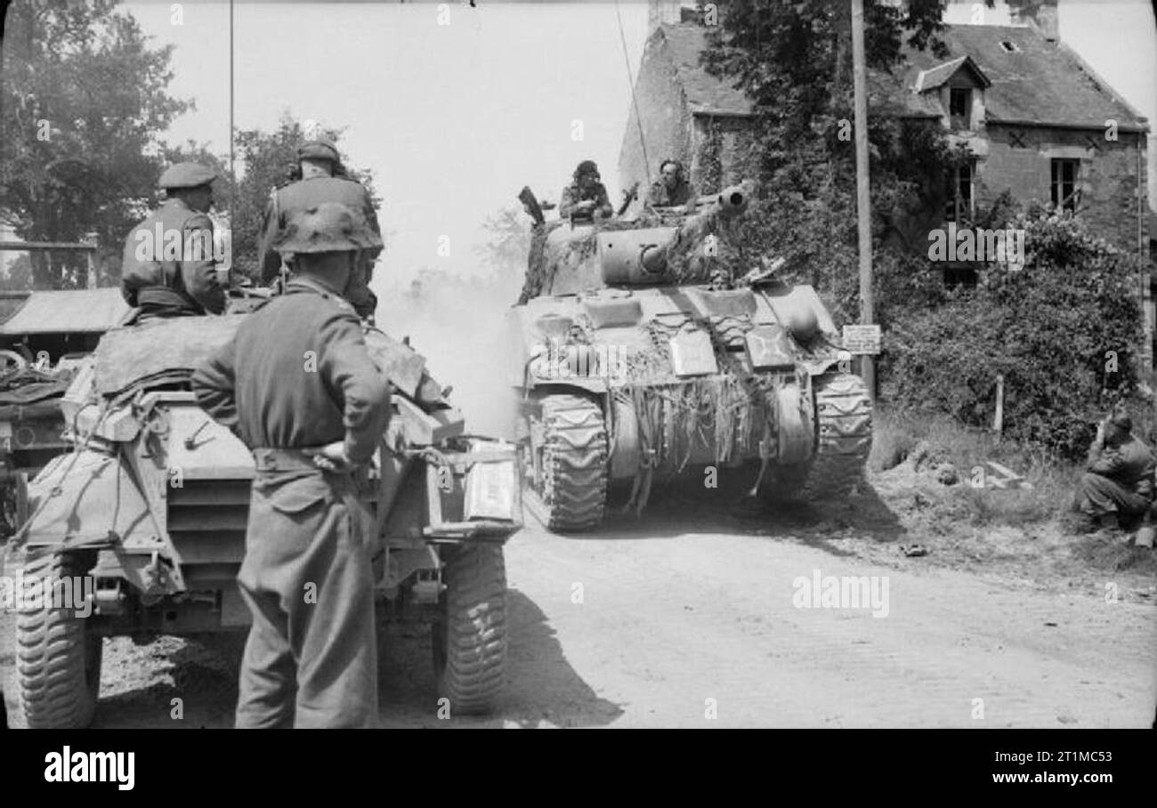 The British Army in the Normandy Campaign 1944 A Sherman Firefly passes ...