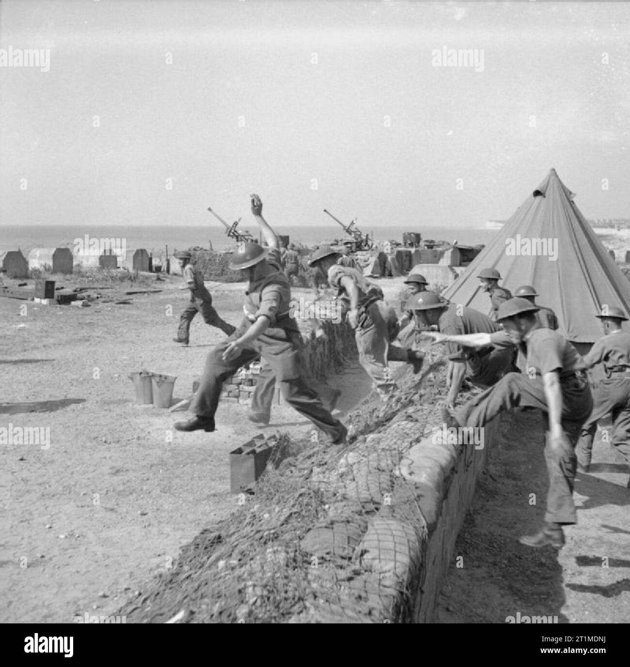 The British Army in the United Kingdom 1939-45 Crews rush to their guns at a South Coast anti ...