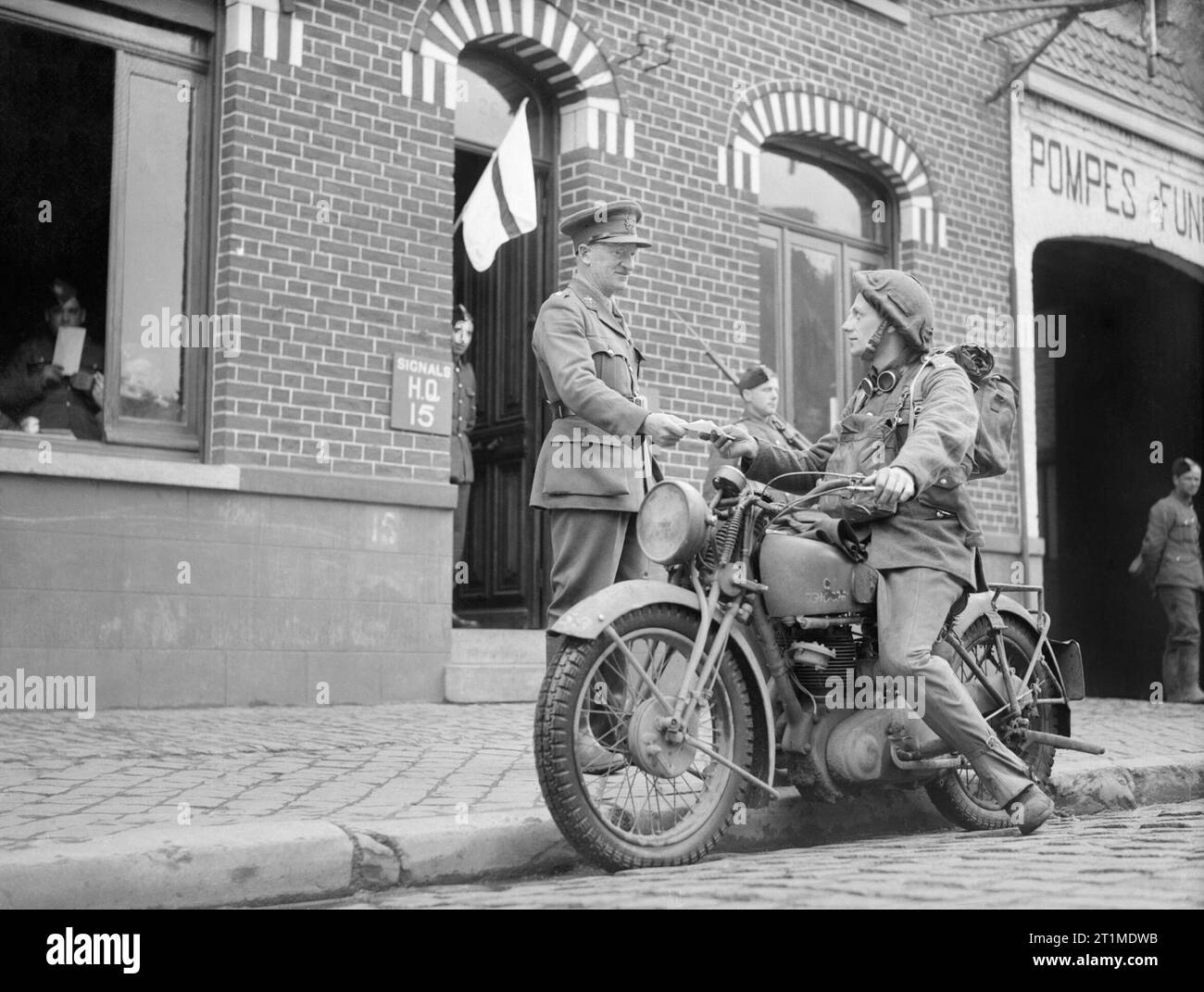 A motorcycle despatch rider delivers a message to the signals office of ...