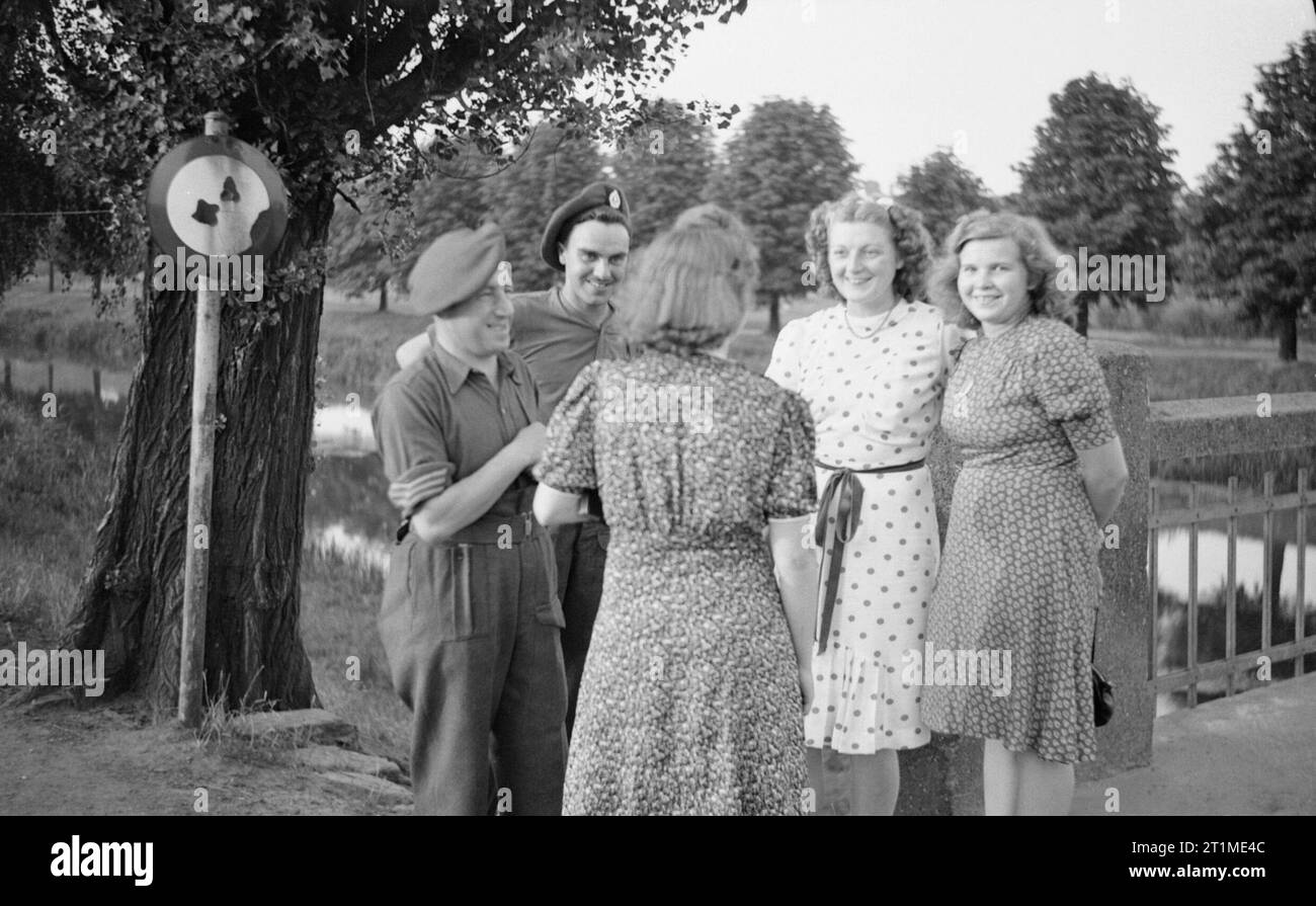 British soldiers chatting to German girls, 16 July 1945. Two British ...