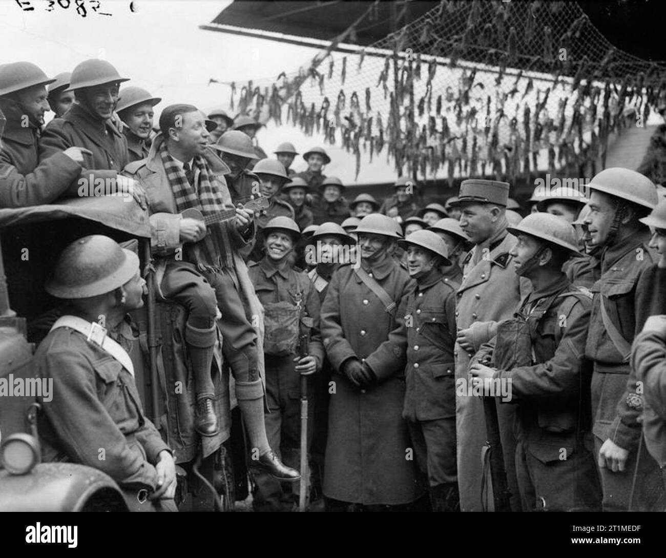 The British Expeditionary Force in France, 1940 George Formby entertains a crowd of soldiers ...