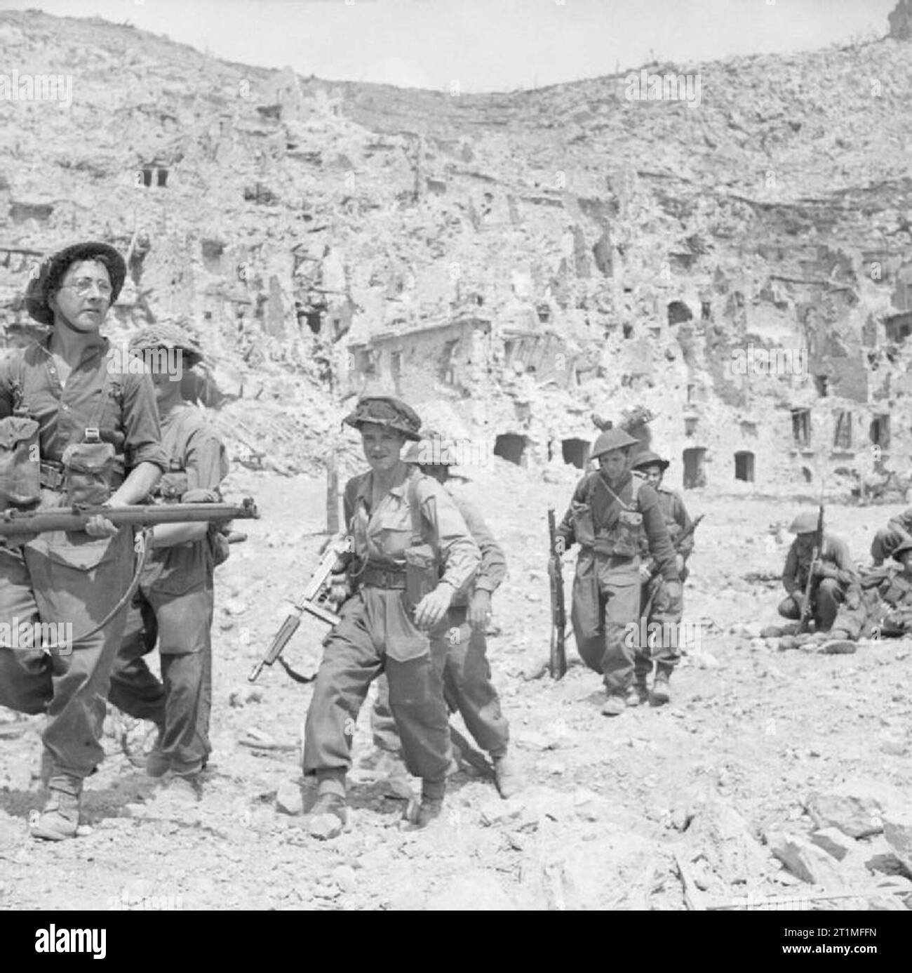 Infantry of the East Surrey Regiment enter the ruins of Cassino, Italy ...